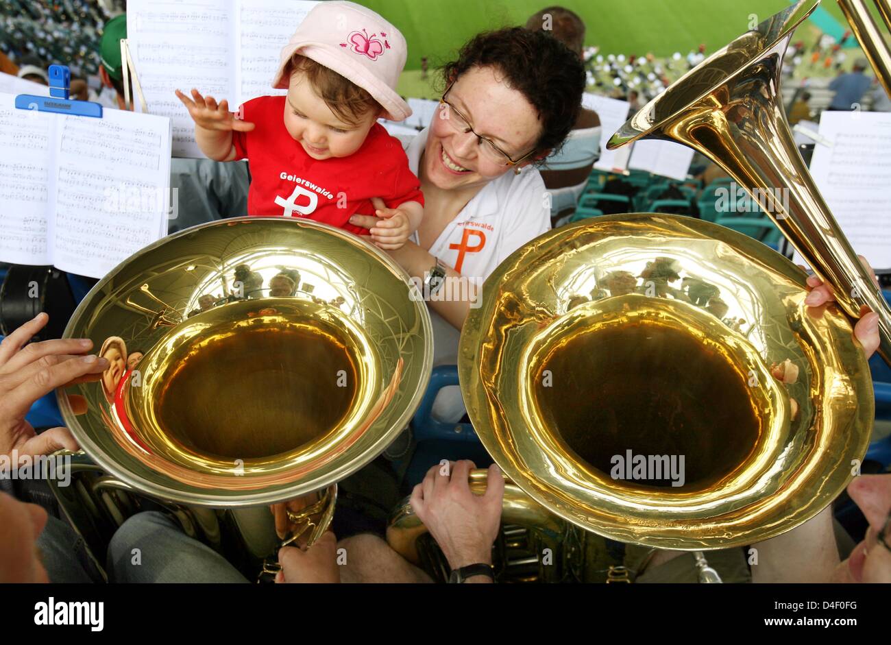 A mother and child take a look at tubas at the final service of the ...