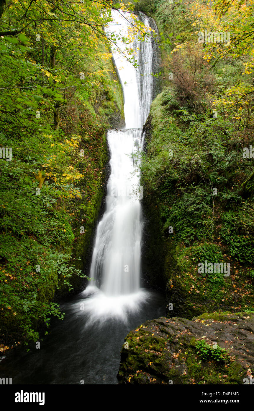 Waterfall rushing over rocky hillside Stock Photo - Alamy