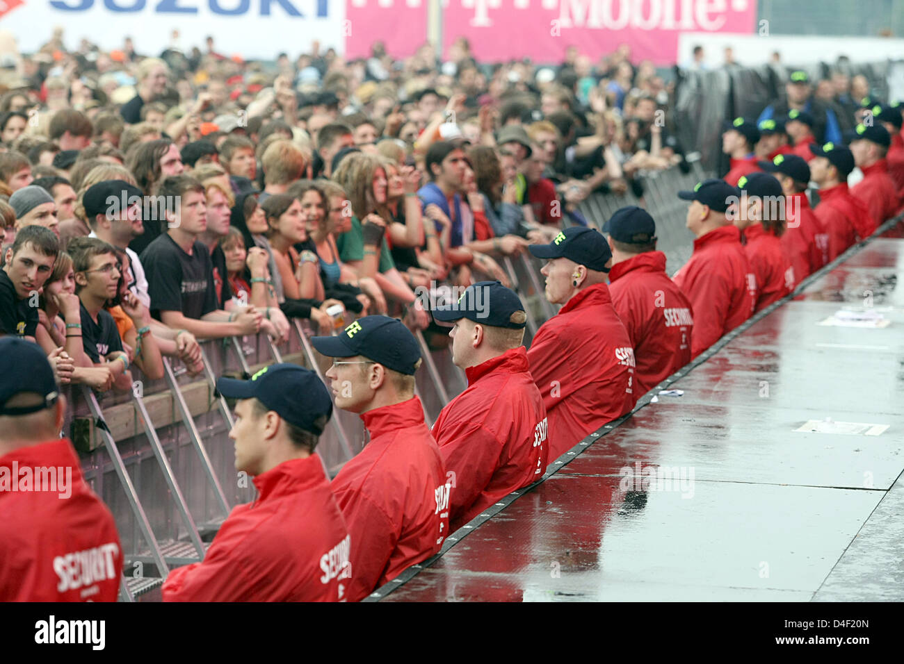 Security guards dressed in red rain jacket line up in front of the main ...