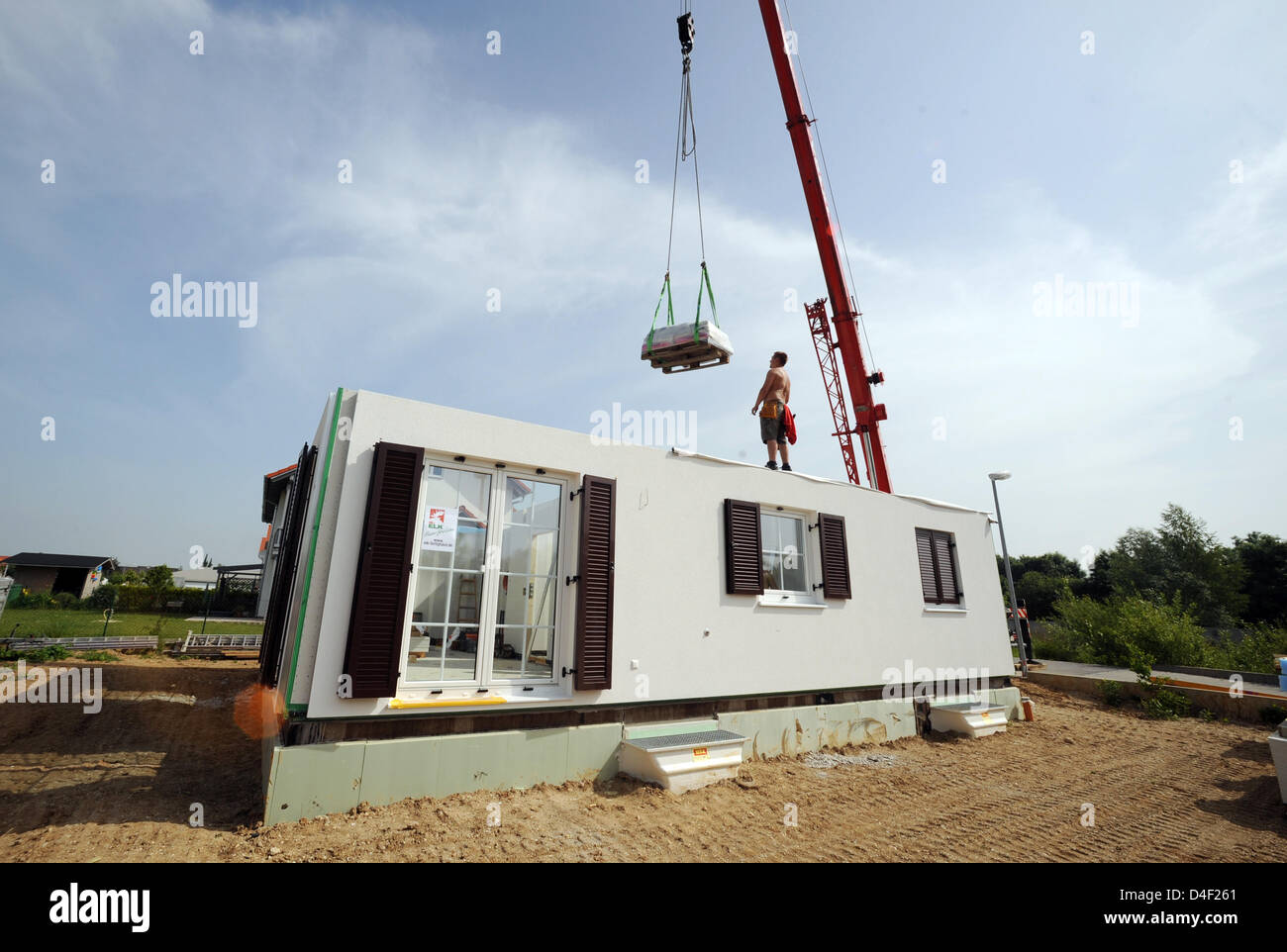 A prefabricated house is constructed with a crane in Straubing, Germany ...