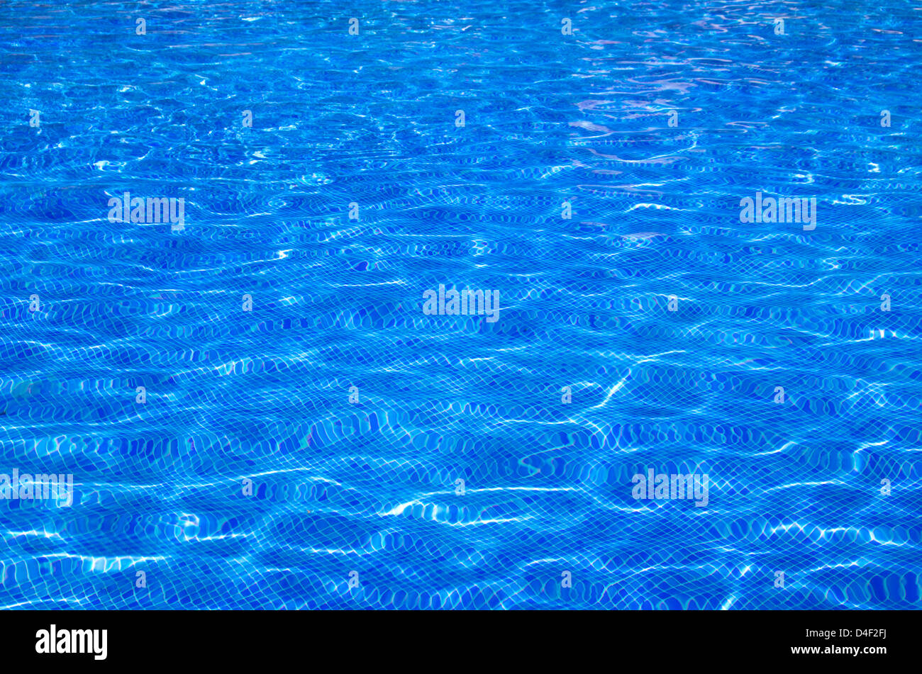 Blue pool water with sun reflections Stock Photo - Alamy