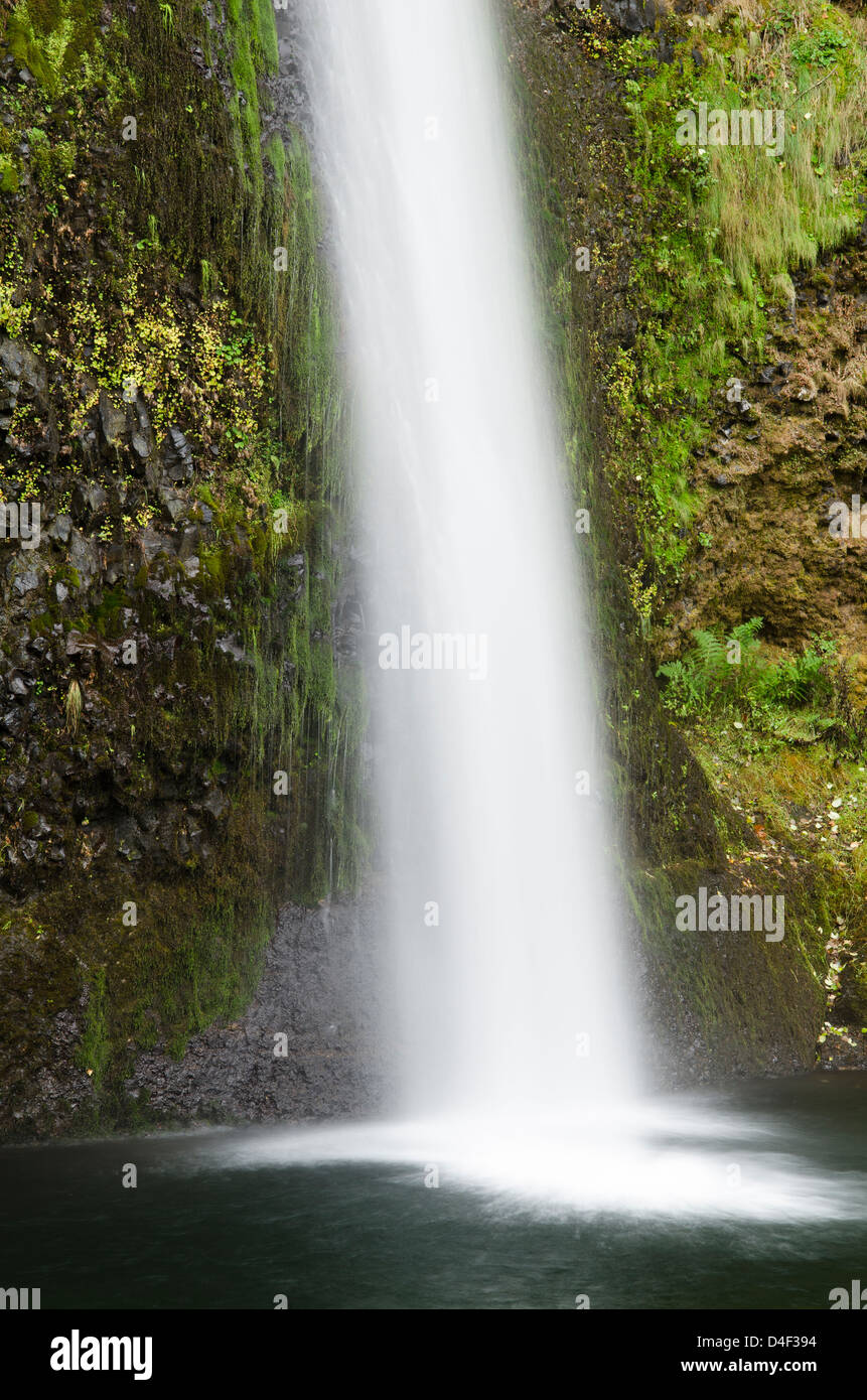 Waterfall emptying into still pool Stock Photo - Alamy