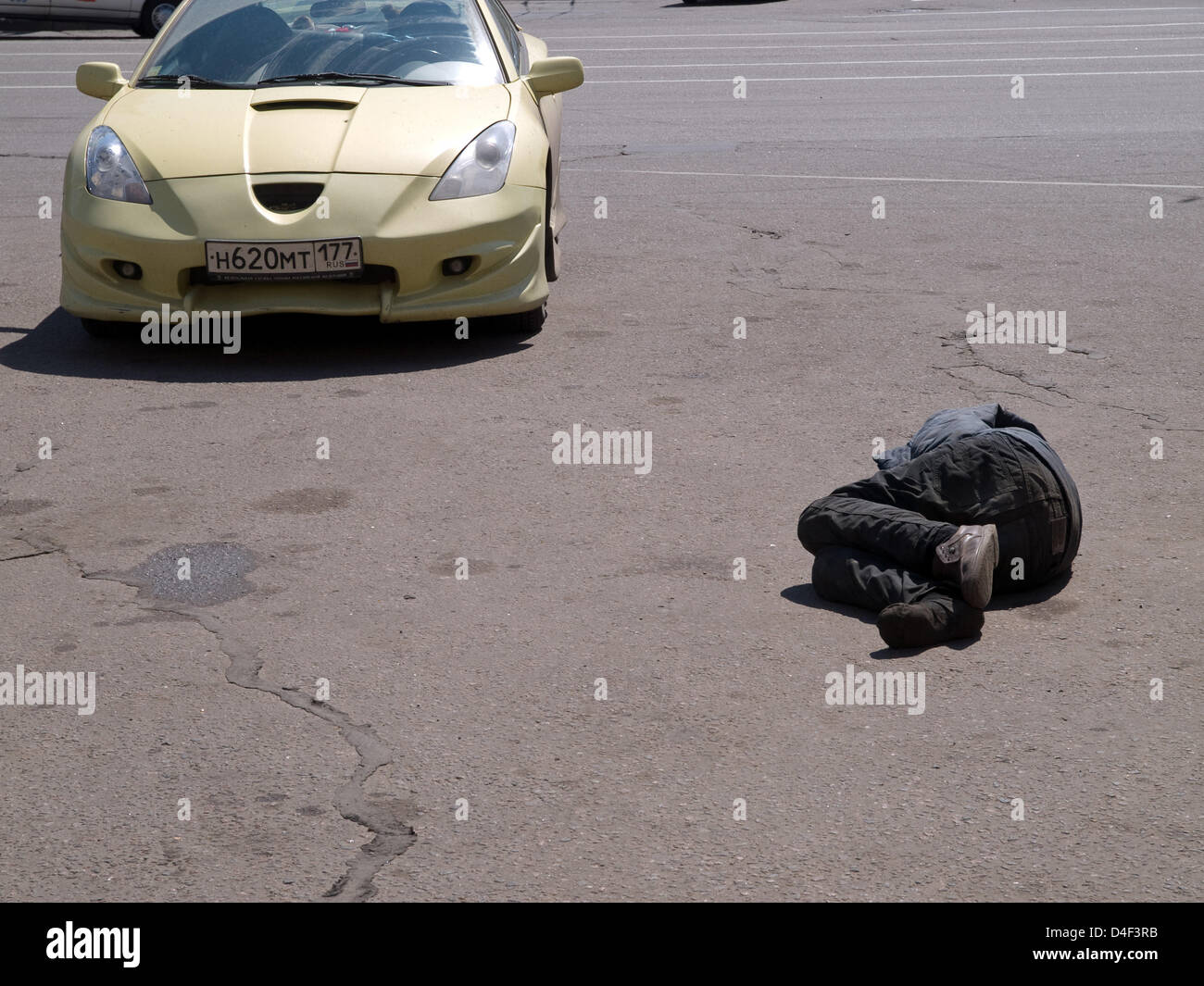 A homeless man sleeps on a parking lot across Kazanski station in ...