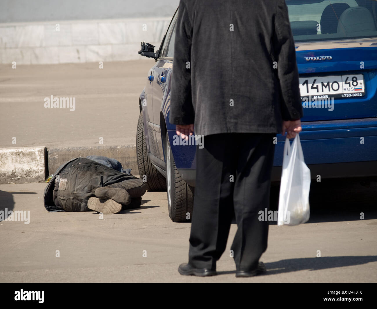 A homeless man sleeps on a parking lot across Kazanski station in ...