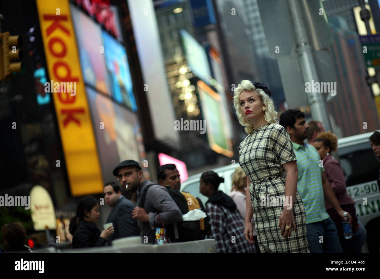 A model poses right in the middle of Times Square in Manhattan, New ...