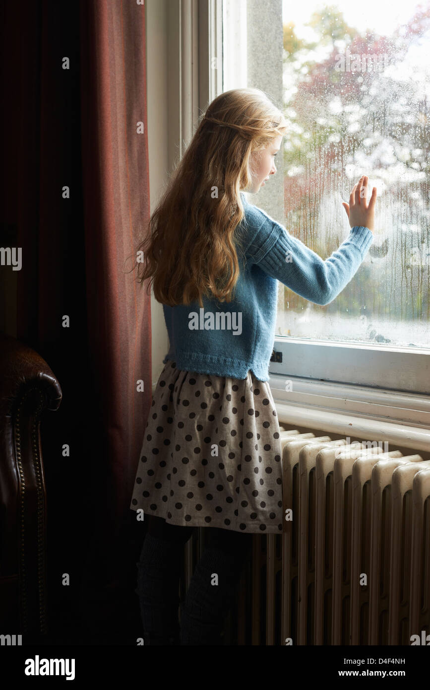 Girl looking out window Stock Photo - Alamy
