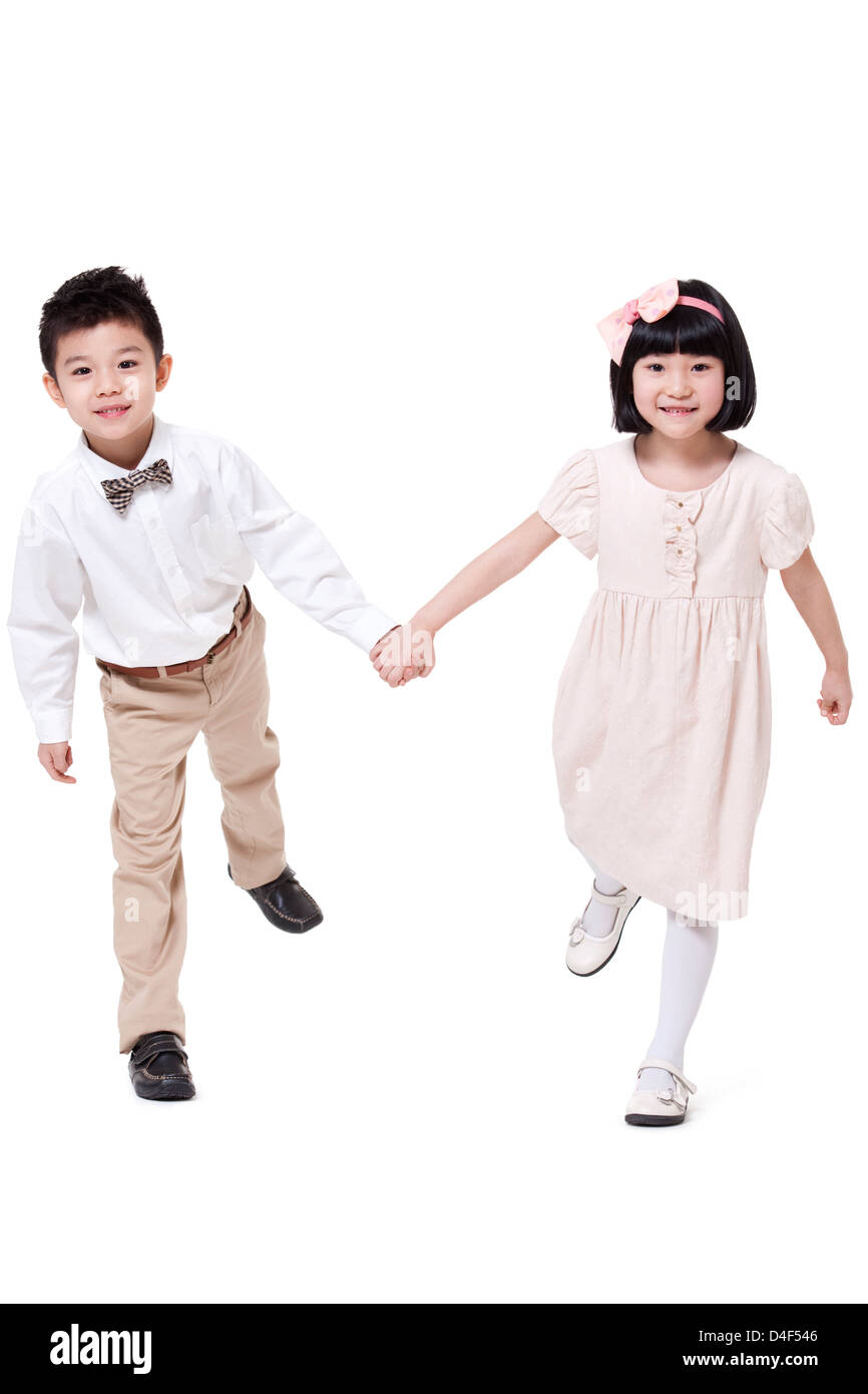 Cute boy and girl hand in hand Stock Photo - Alamy