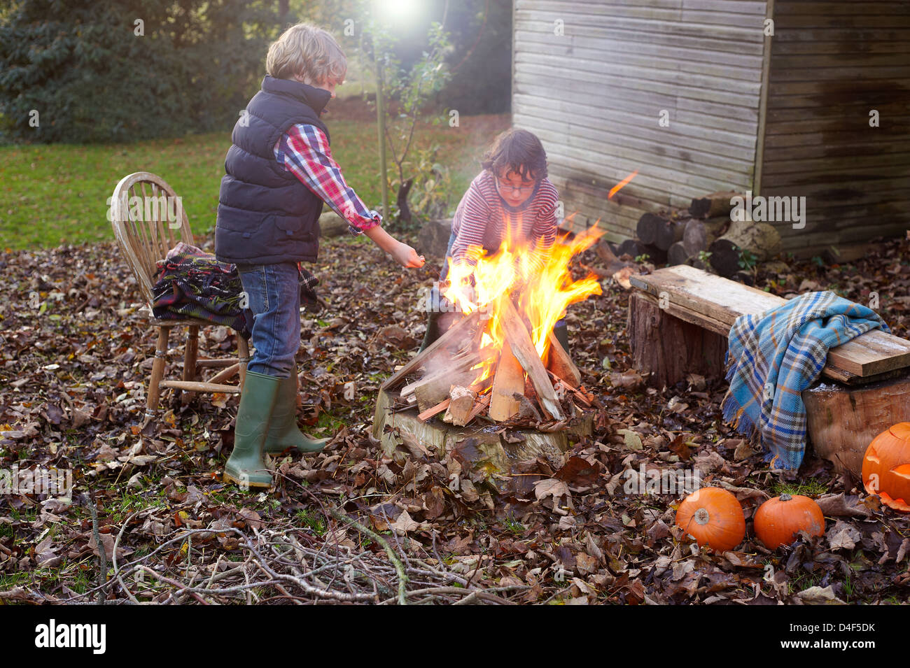 Children building bonfire outdoors Stock Photo - Alamy