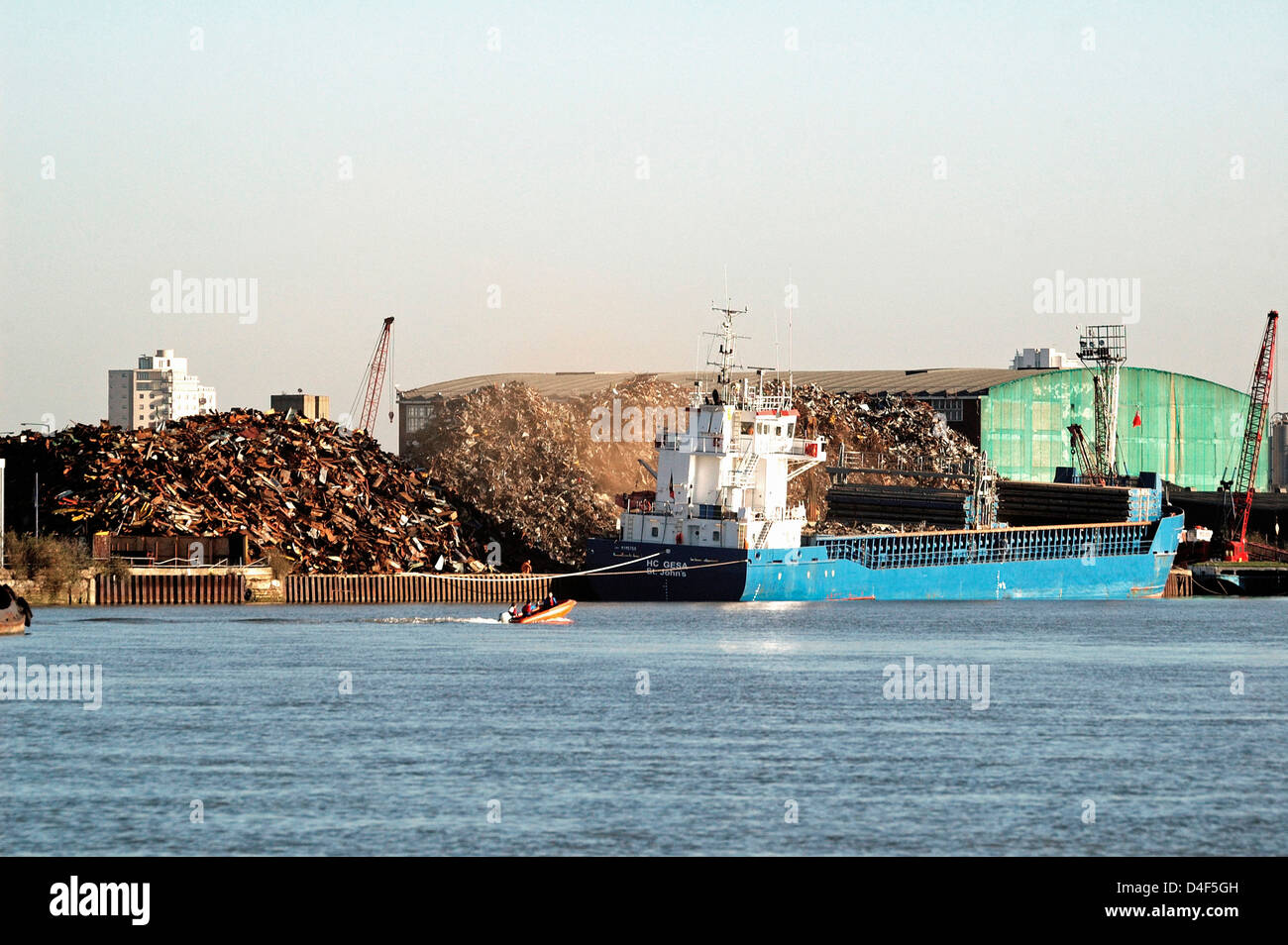 Boat loading or unloading scrap metal, River Thames, London, England UK ...