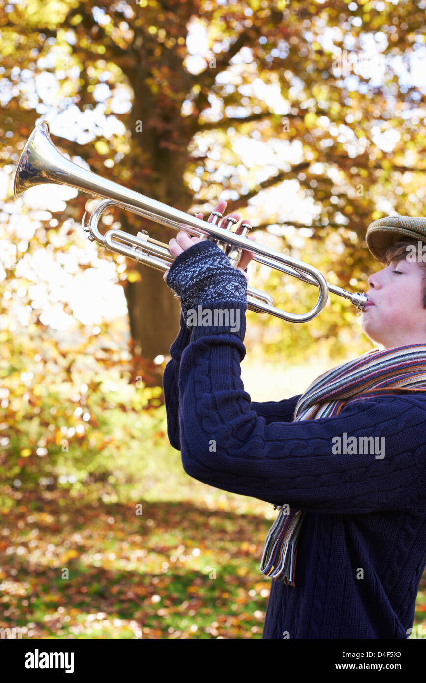 Teenage boy playing trumpet outdoors Stock Photo - Alamy