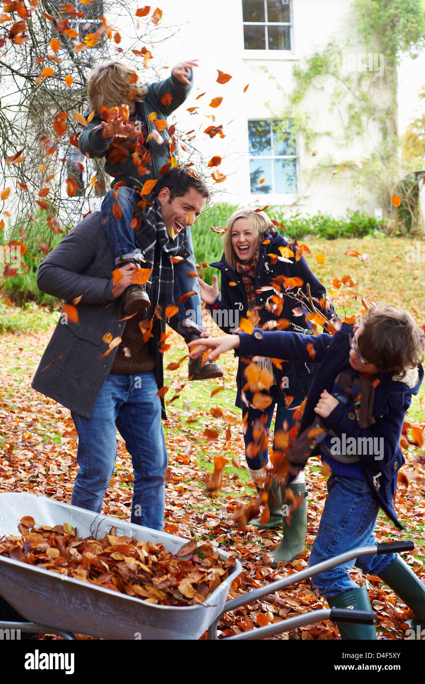 Family playing in autumn leaves Stock Photo - Alamy