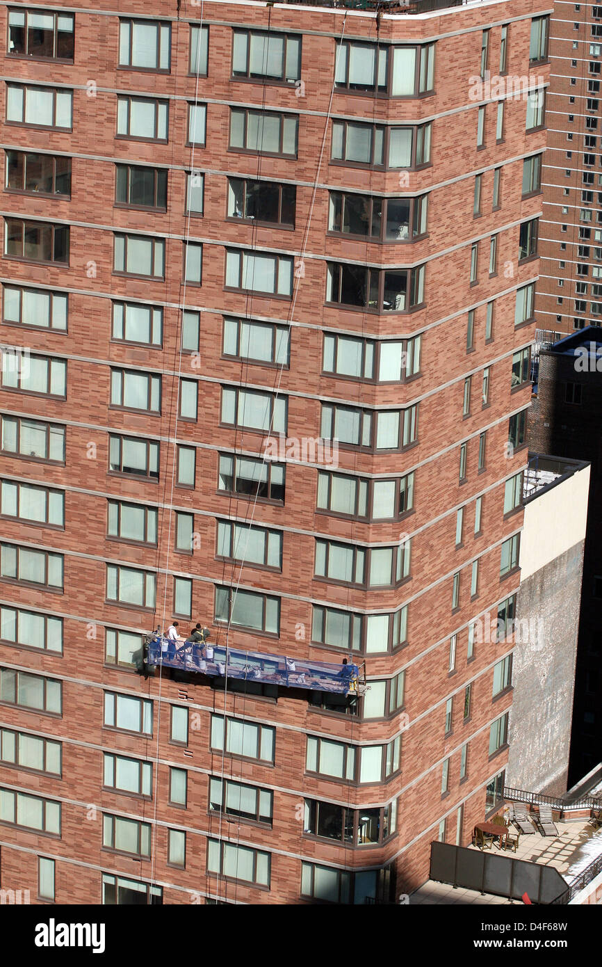 Workers do maintenance work on a high rise building in Manhattan, New ...