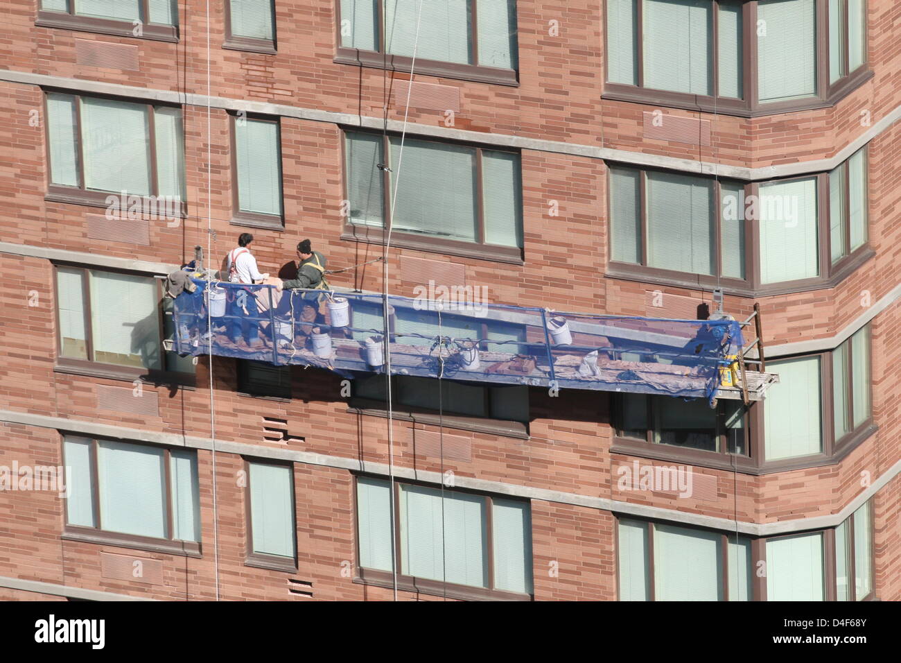 Workers do maintenance work on a high rise building in Manhattan, New ...
