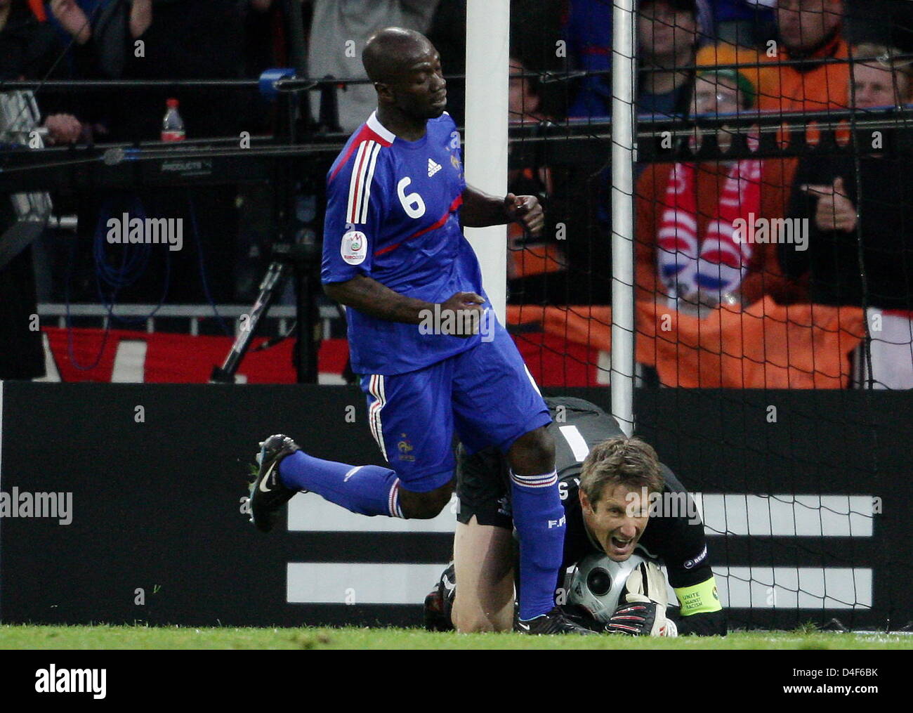 Goalkeeper Edwin van der Saar (R) of Netherlands saves a goal attempt ...