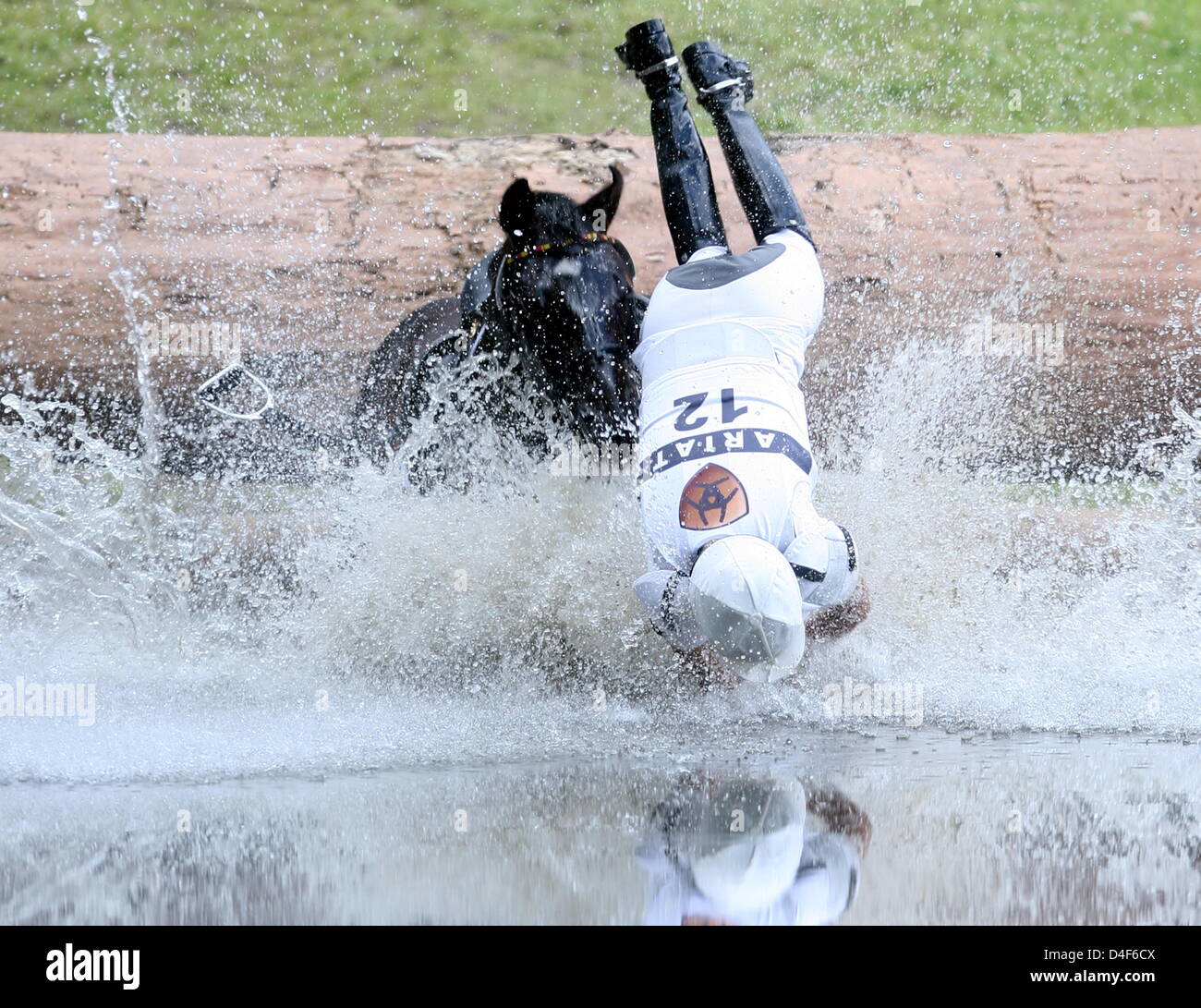 German Alexa Bendfeldt falls off her horse El Greco during the terrain ...