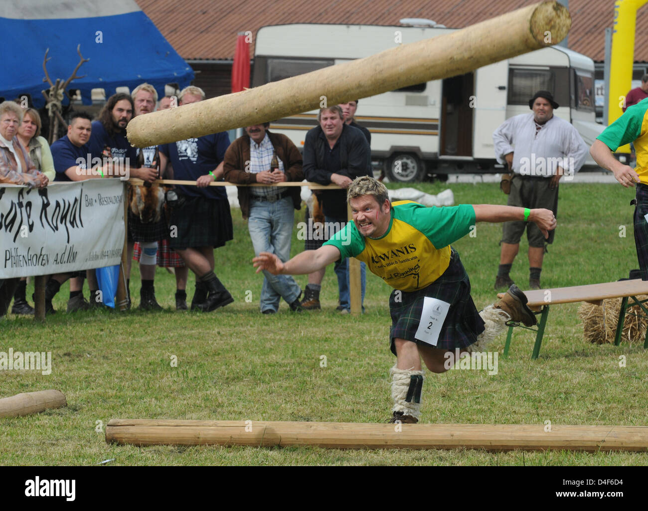 A participant of the Bavarian Highland Games competes in tree trunk ...