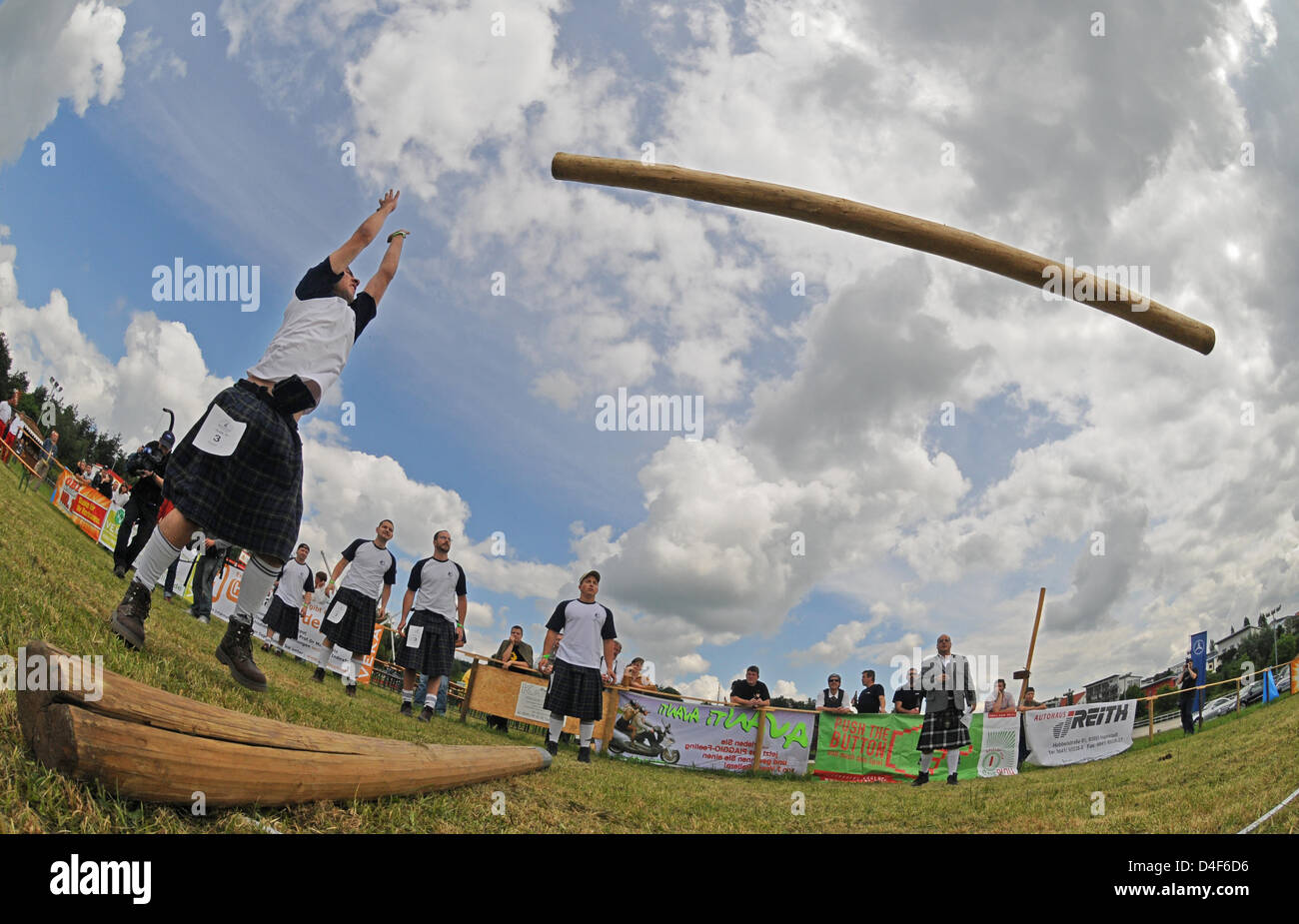 A participant of the Bavarian Highland Games competes in tree trunk ...