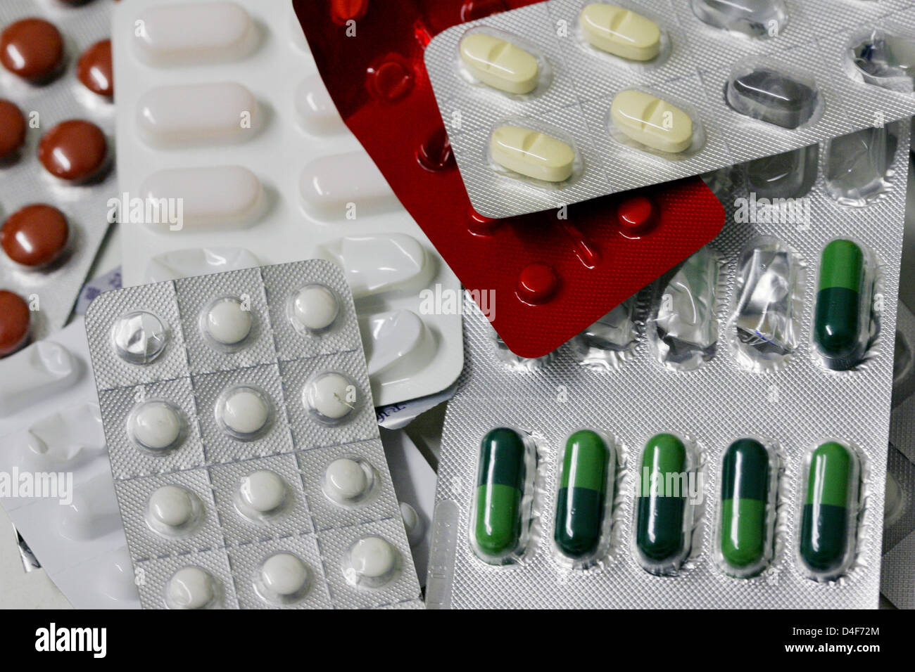 Packed and unpacked pharmaceuticals in various colours, shapes and ...