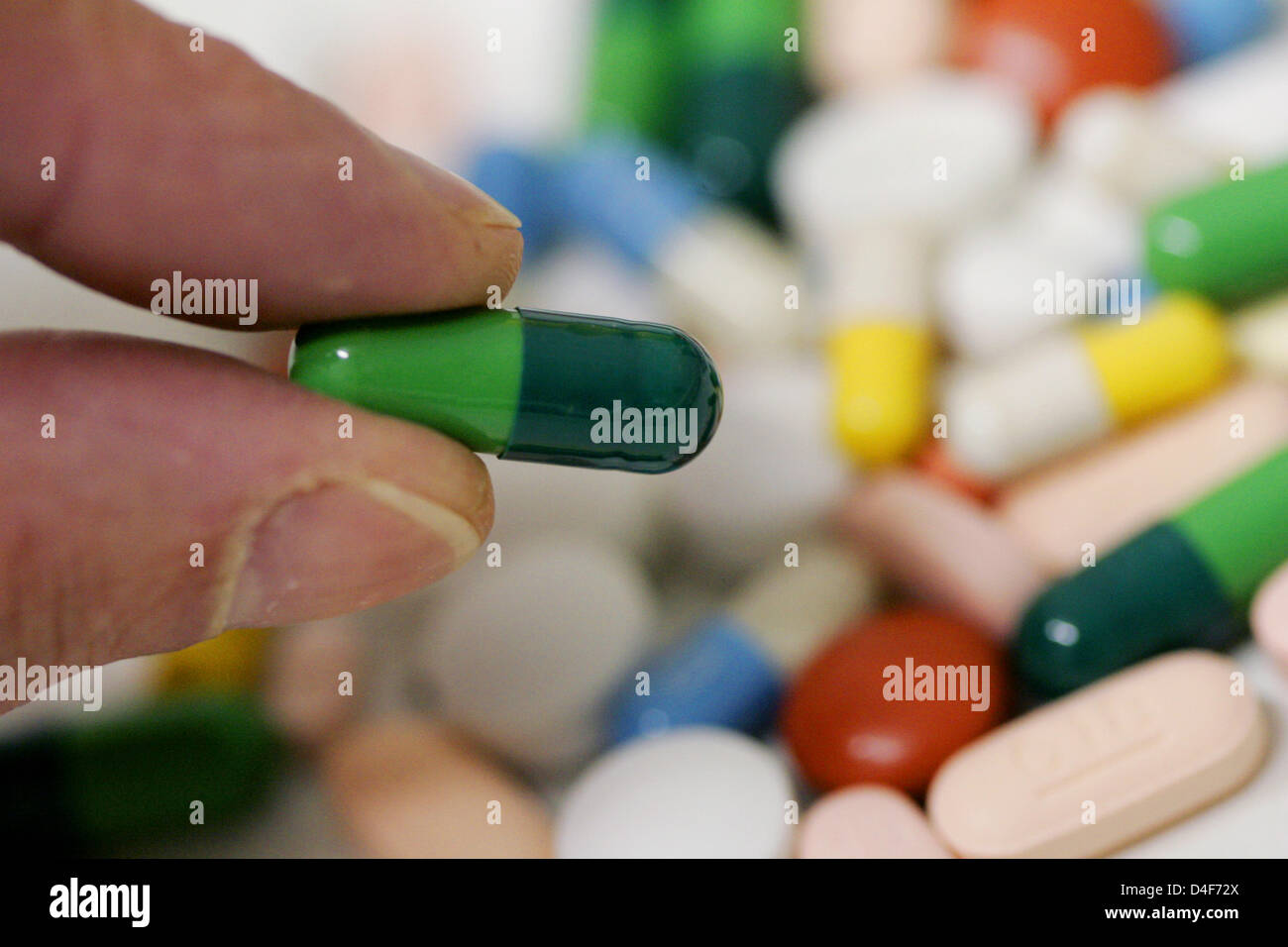 Packed and unpacked pharmaceuticals in various colours, shapes and ...