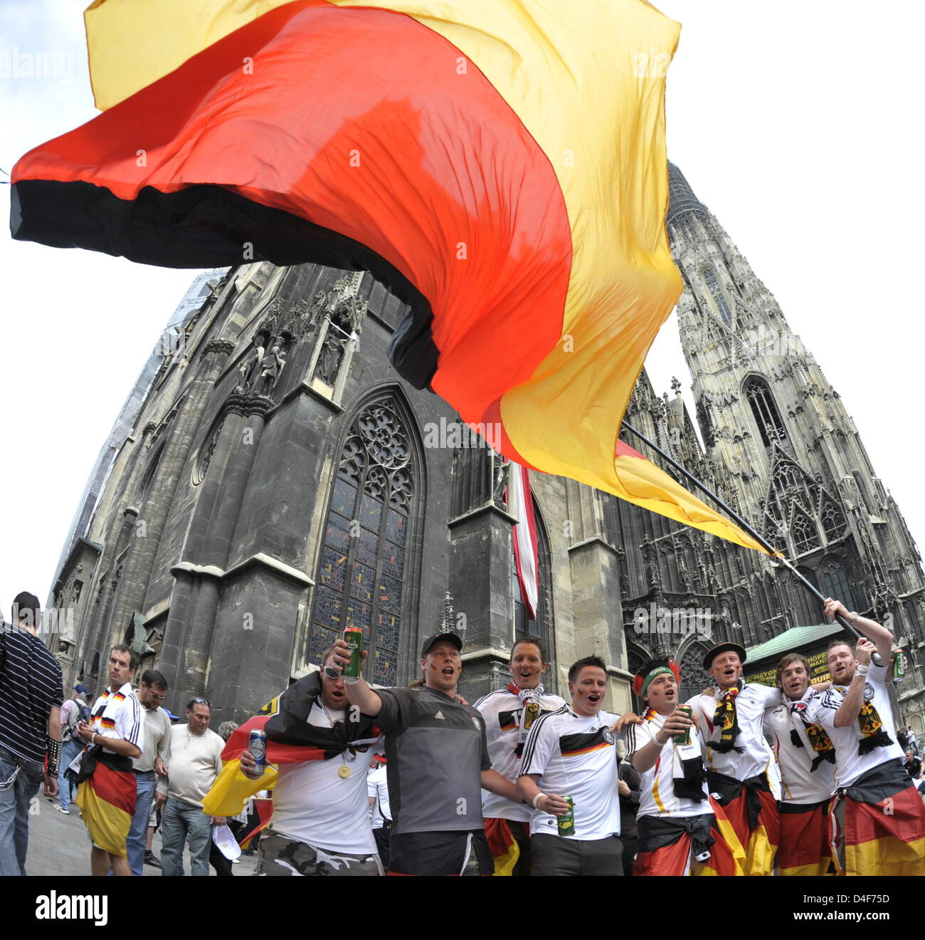 German supporters from Dortmund cheer in front of the Stephansdom ...