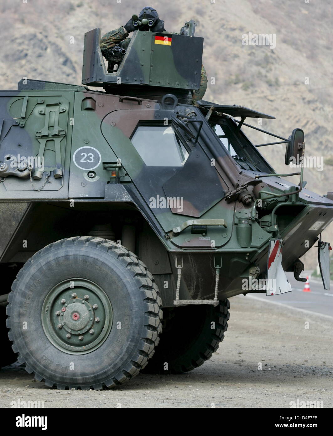 A German Bundeswehr soldier monitors from the top of an armoured ...