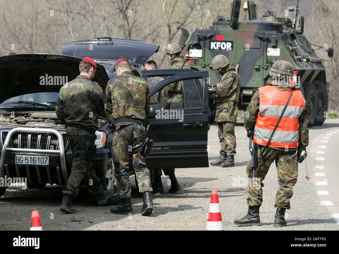 German Bundeswehr soldiers check cars and drivers during a road check ...