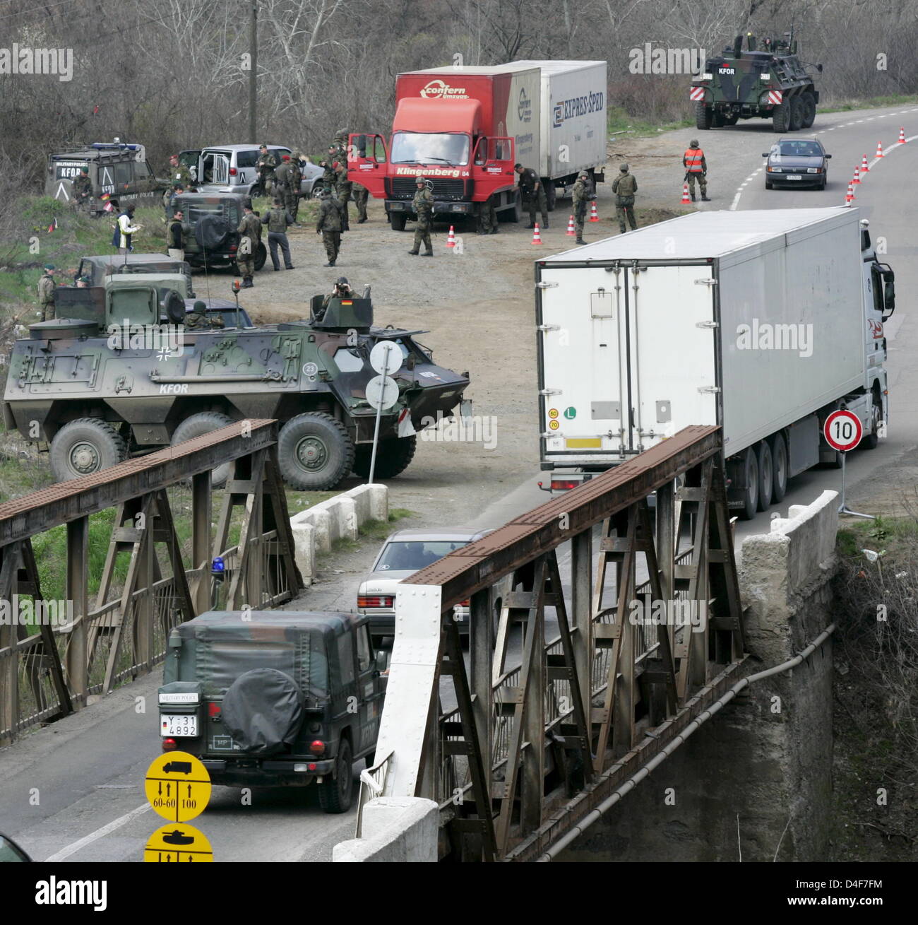 German Bundeswehr soldiers check cars and drivers during a road check ...