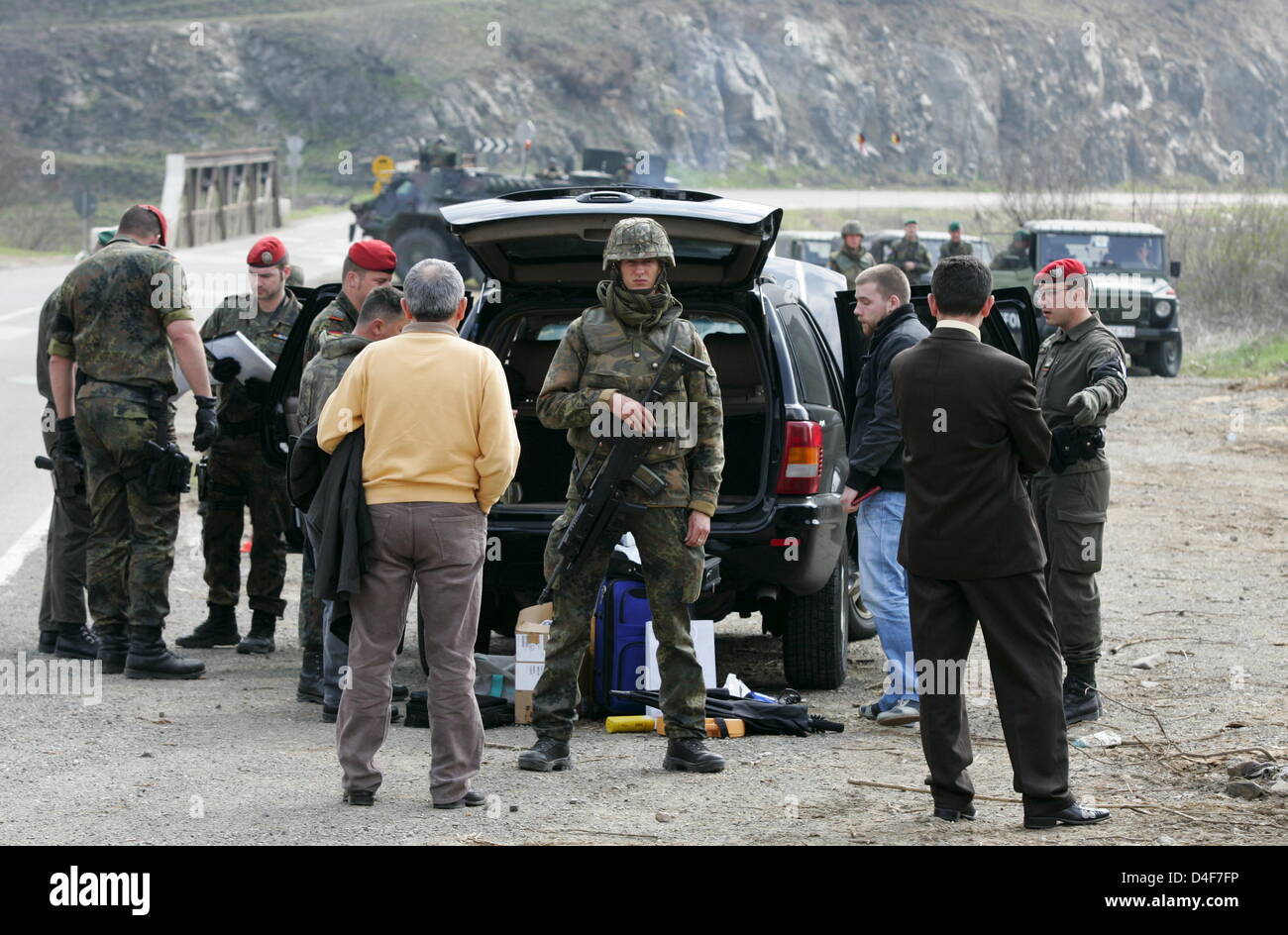 German Bundeswehr soldiers check cars and drivers during a road check ...