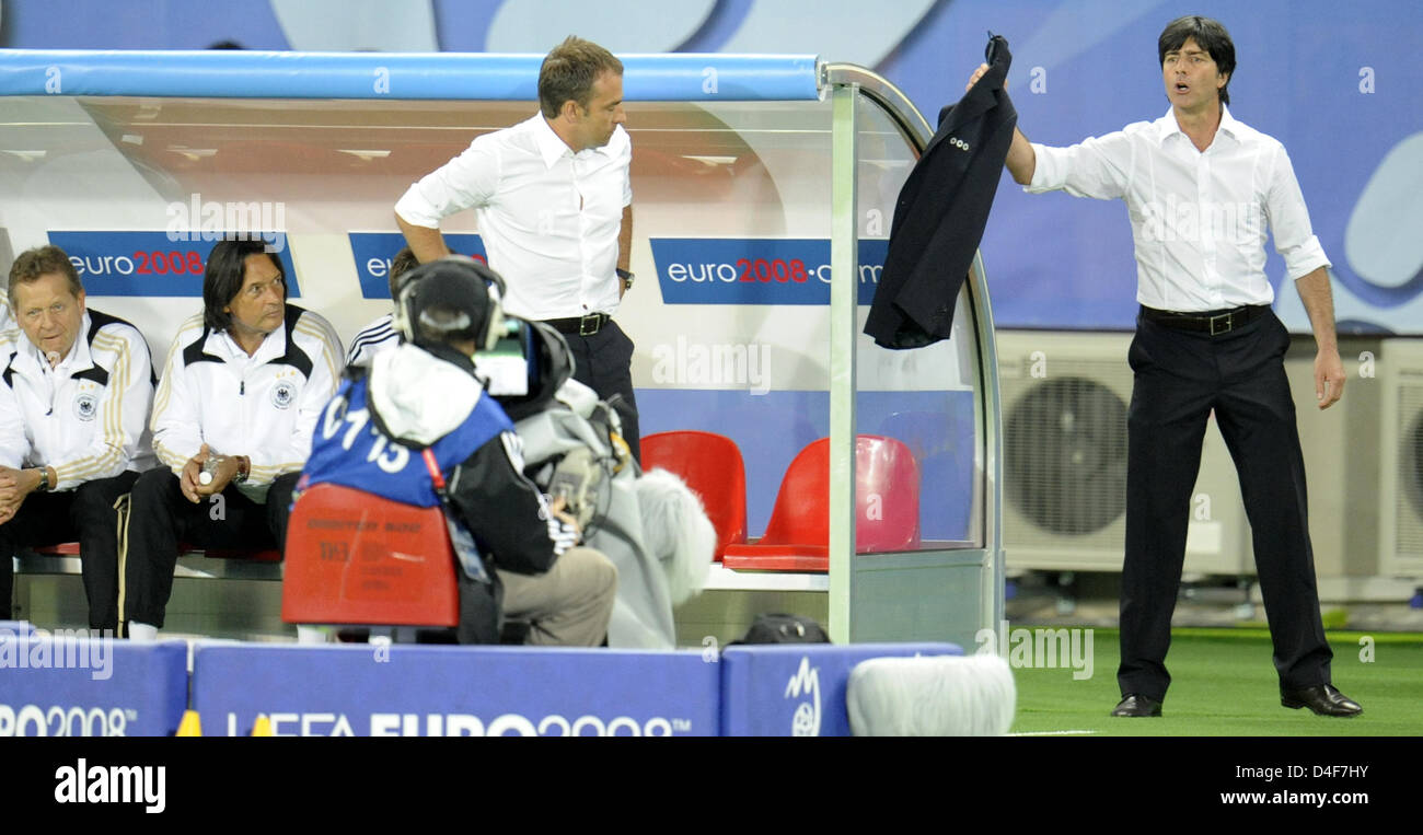 German national soccer team coach Joachim Loew (r) picks up his jacket ...