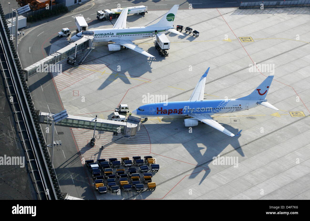 Aerial view on two aircrafts on fingers at the airport Hanover ...
