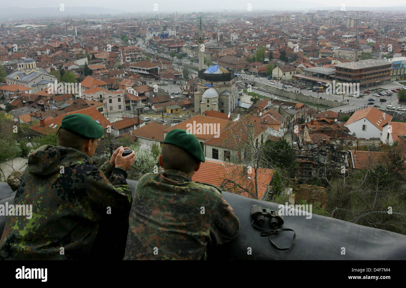 Two soldiers of German Bundeswehr monitor the city of Prizren, Kosovo ...