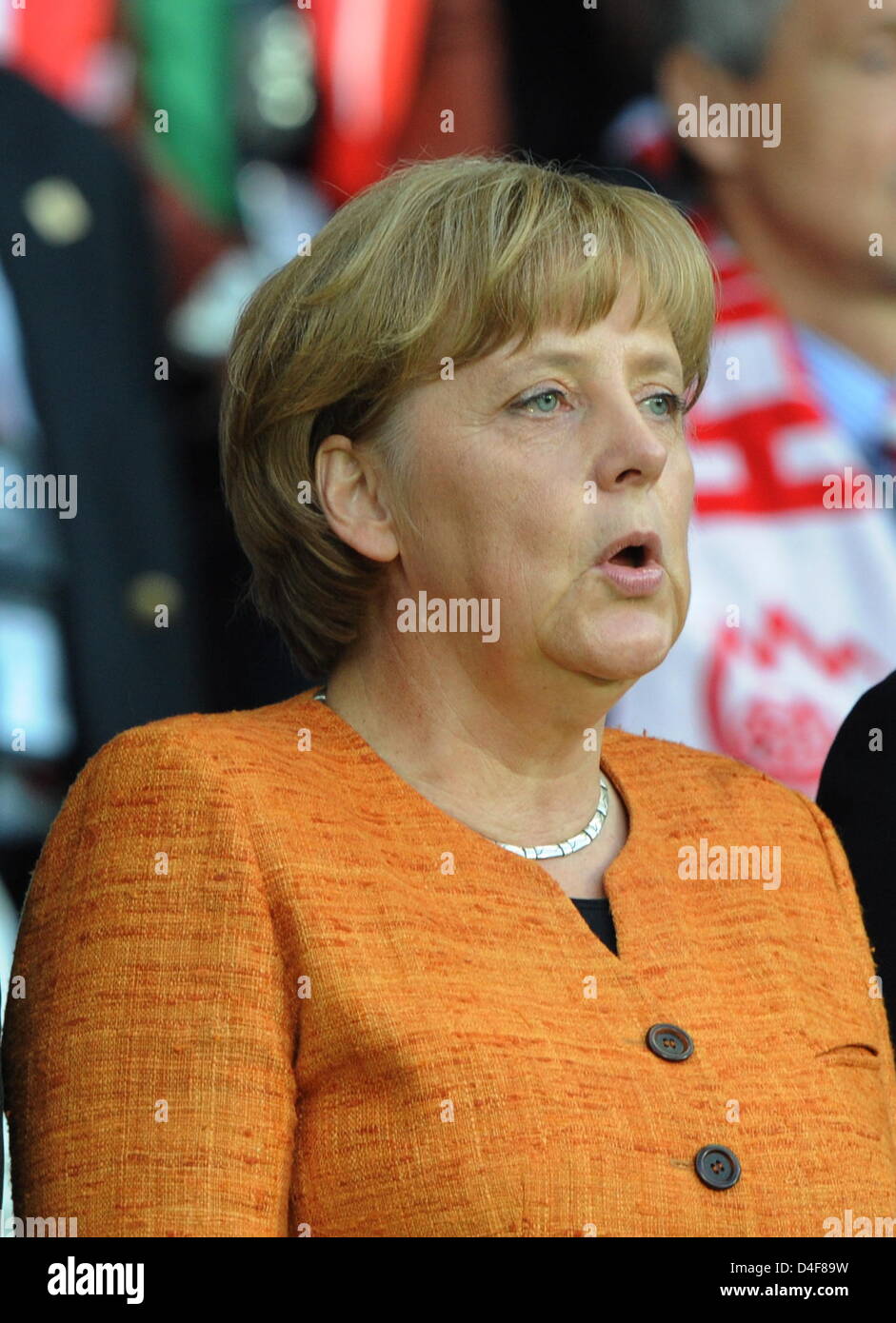German Chancellor Angela Merkel sings the national anthem prior to the ...