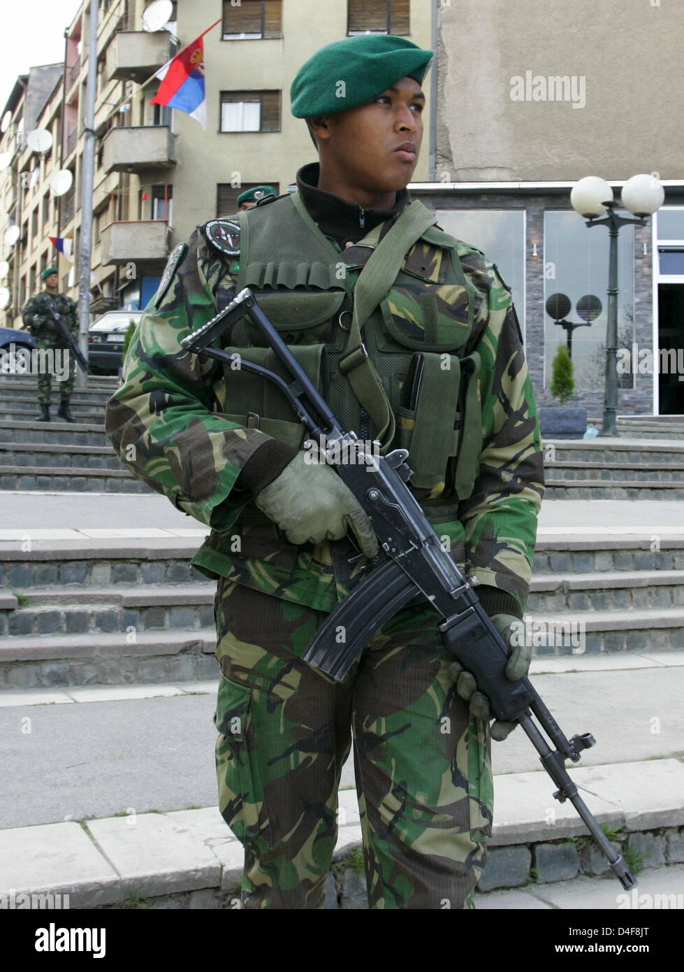 Two armed Portuguese soldiers patrol through downtown Mitrovica, Kosovo ...