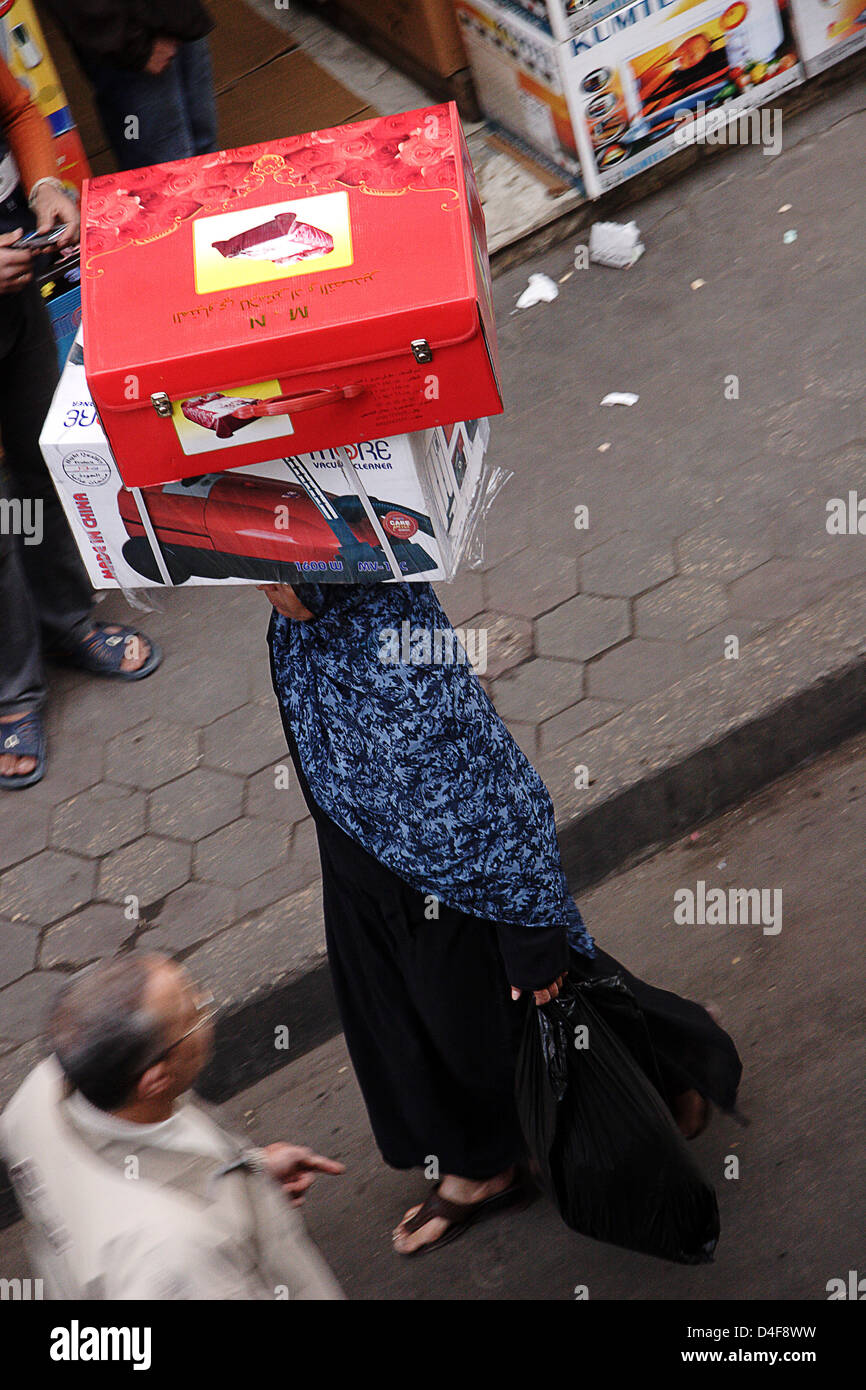 Woman carrying goods in Cairo Stock Photo - Alamy