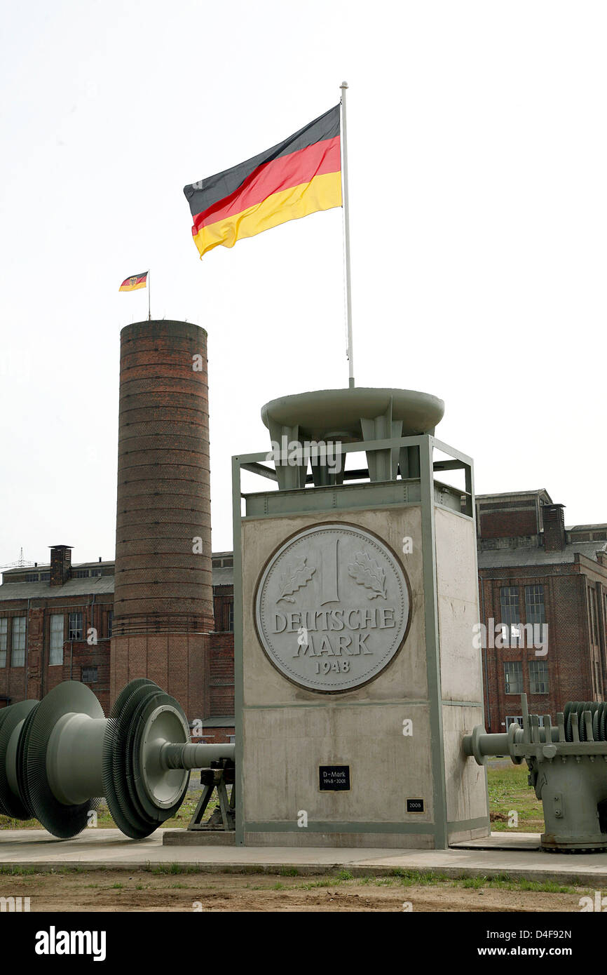 The German flag waves atop the new 'Deutsche Mark' (DM) memorial on a ...