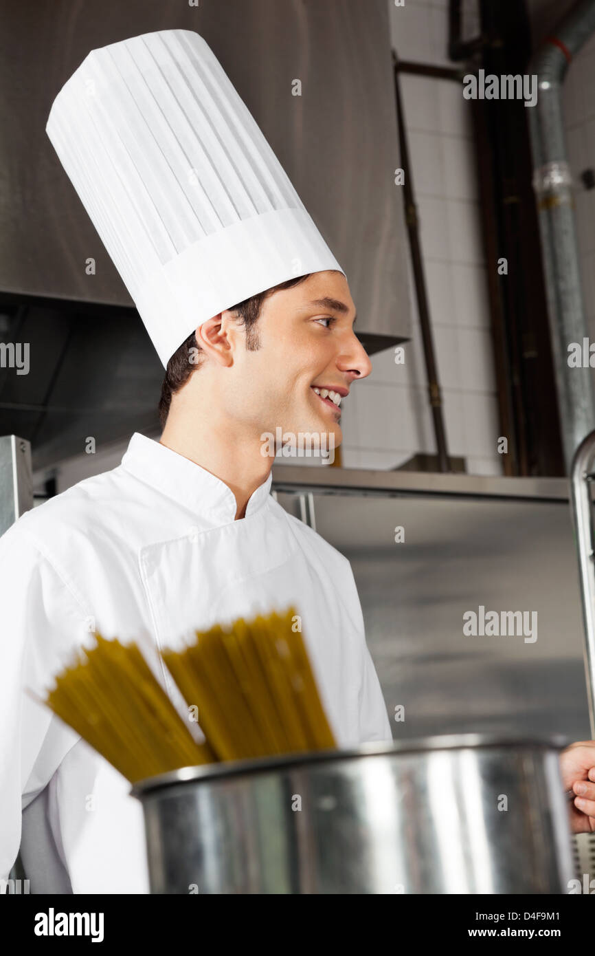 Young Male Chef Standing In Kitchen Stock Photo - Alamy