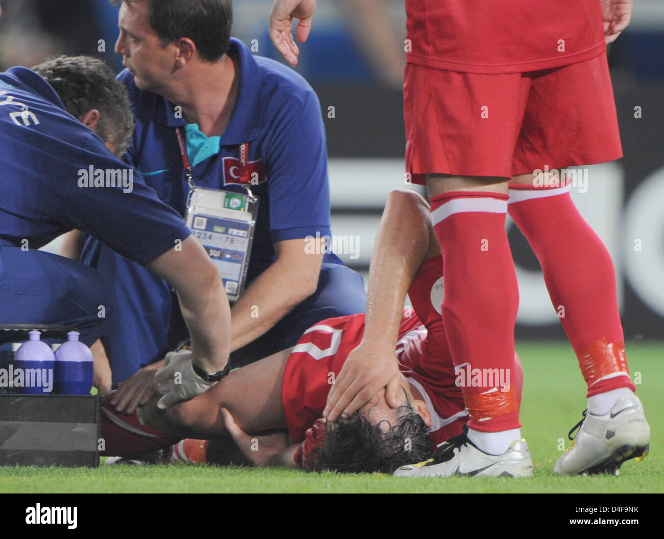 Tuncay Sanli of Turkey receives medical treatment during the UEFA EURO ...