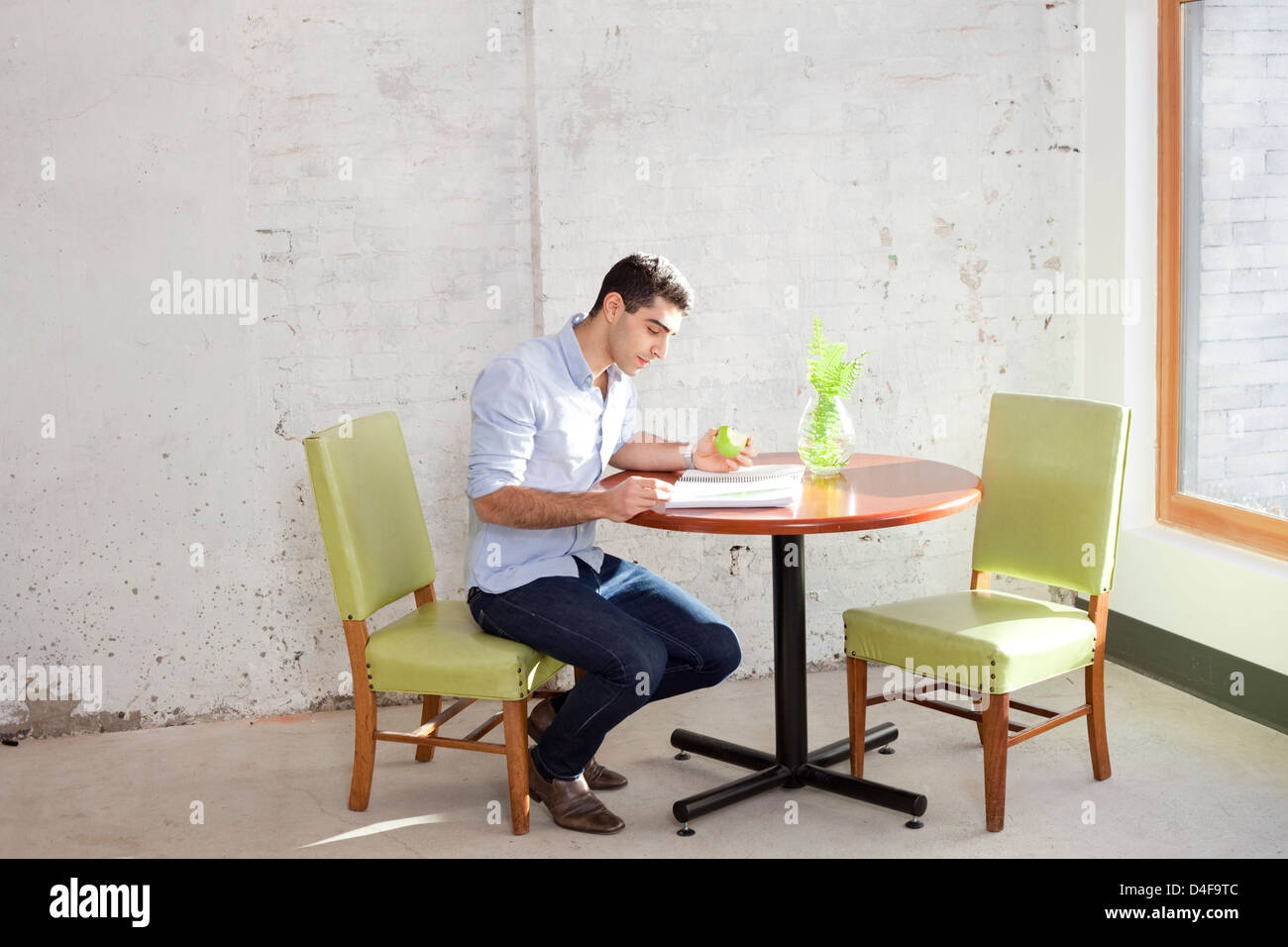 Businessman reading at table in office Stock Photo - Alamy