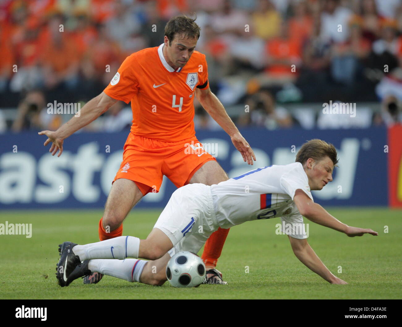 Joris Mathijsen of Netherlands vies with Andrei Arshavin (bottom) of ...
