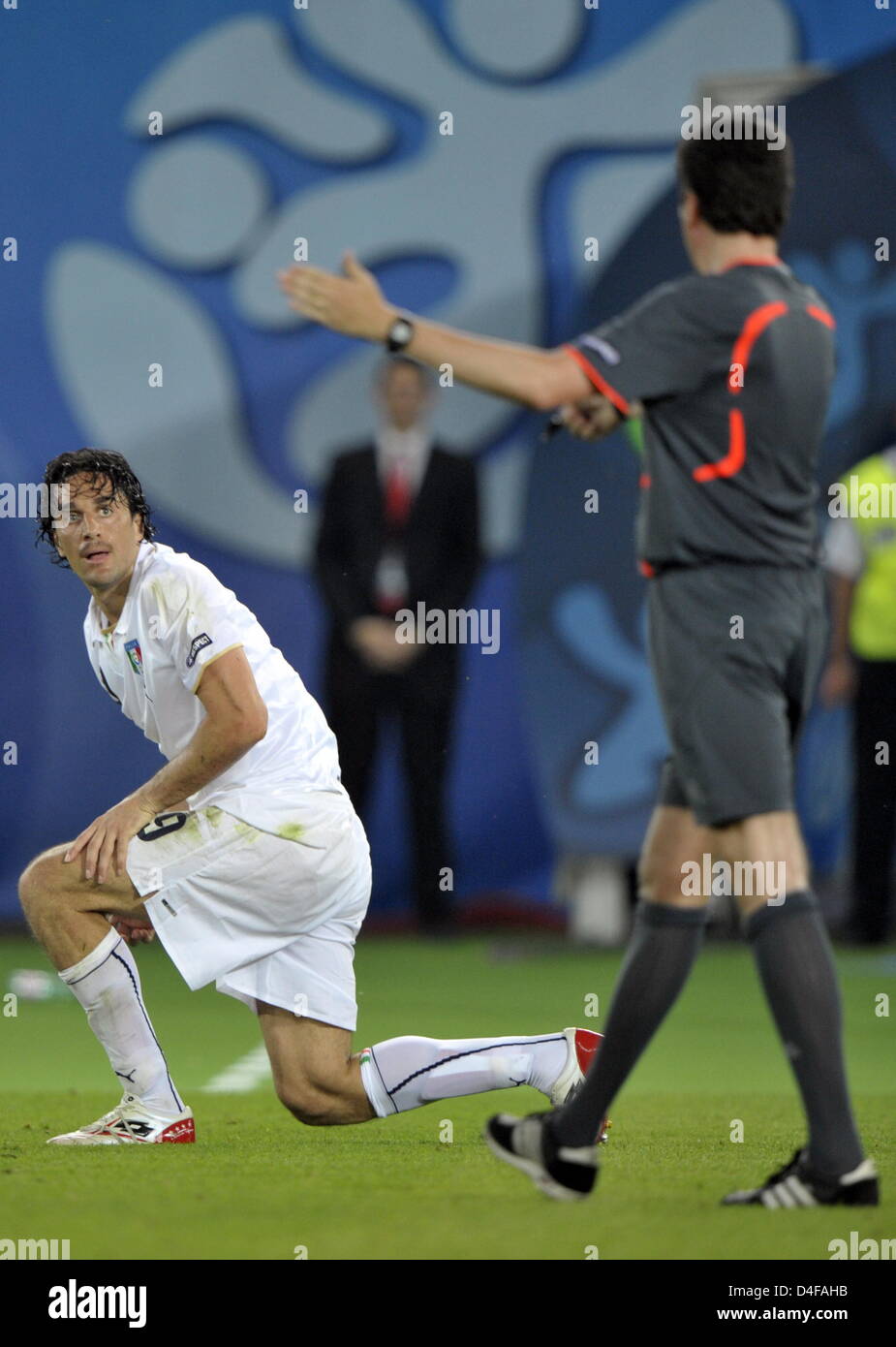 German referee Herbert Fandel (R) talks to Luca Toni of Italy during ...