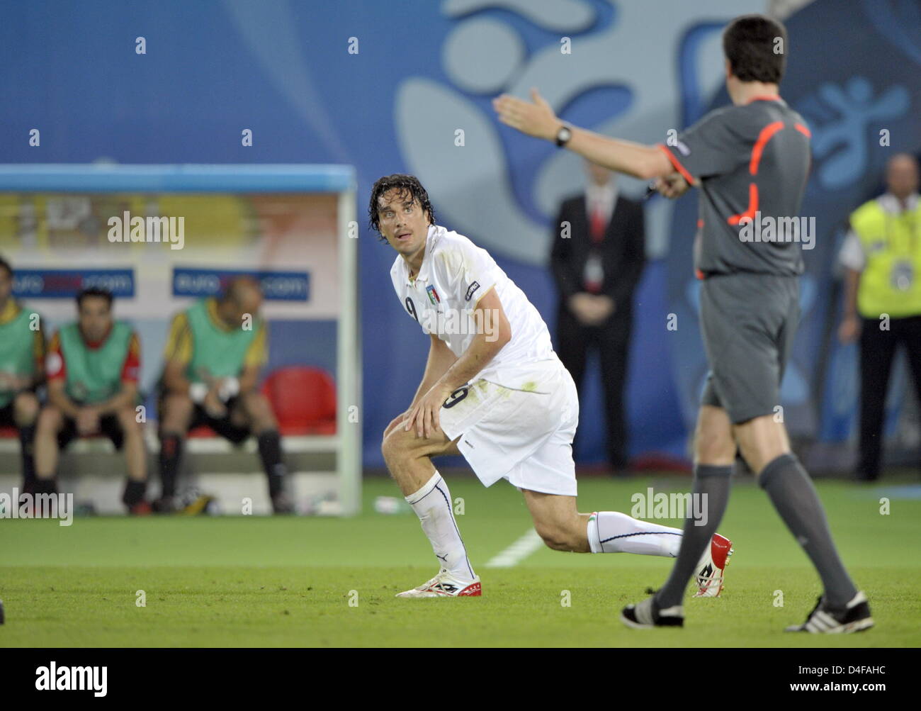 German referee Herbert Fandel (R) talks to Luca Toni of Italy during ...