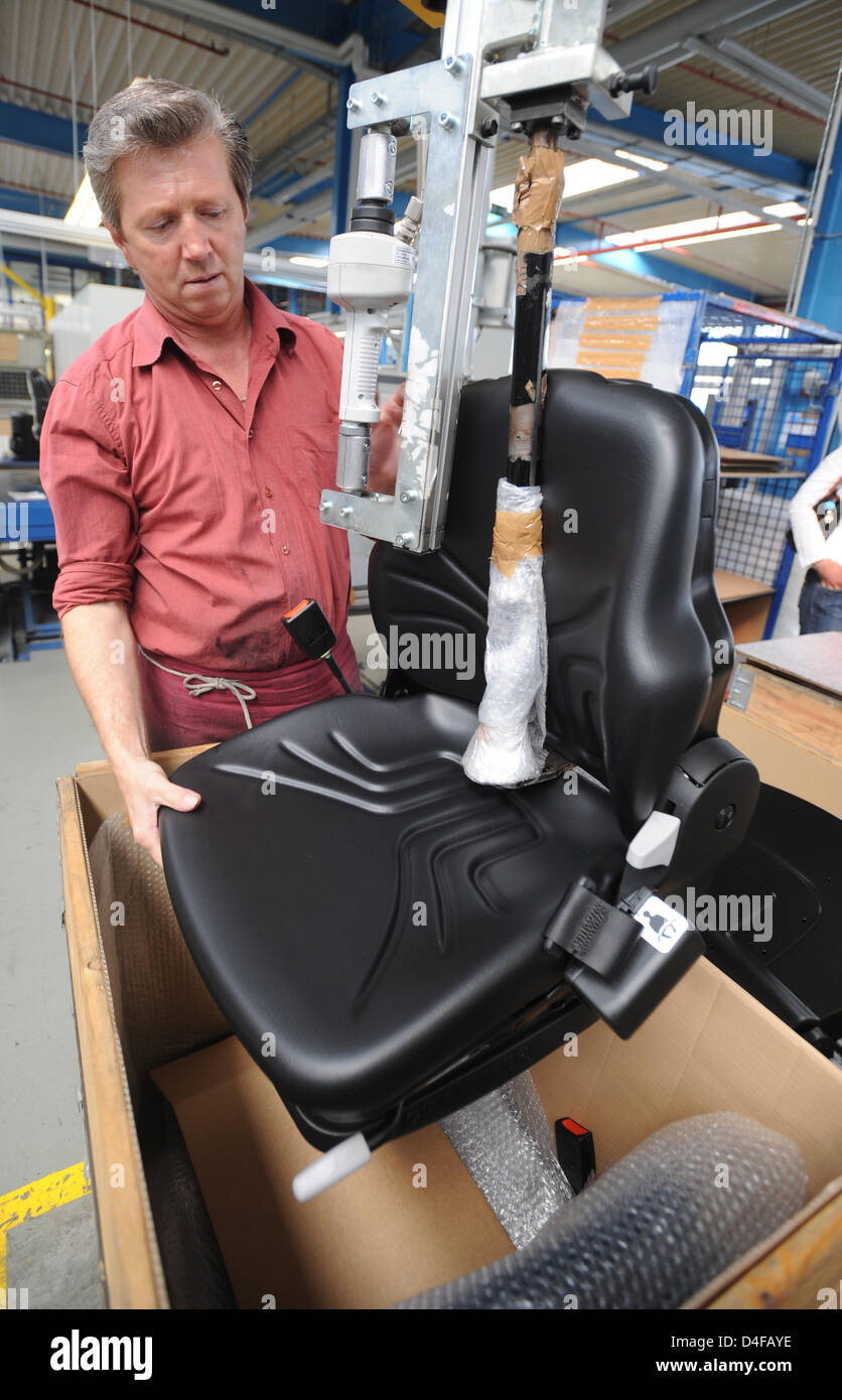 An employee of car supplier Grammer assembles a car seat at the company ...