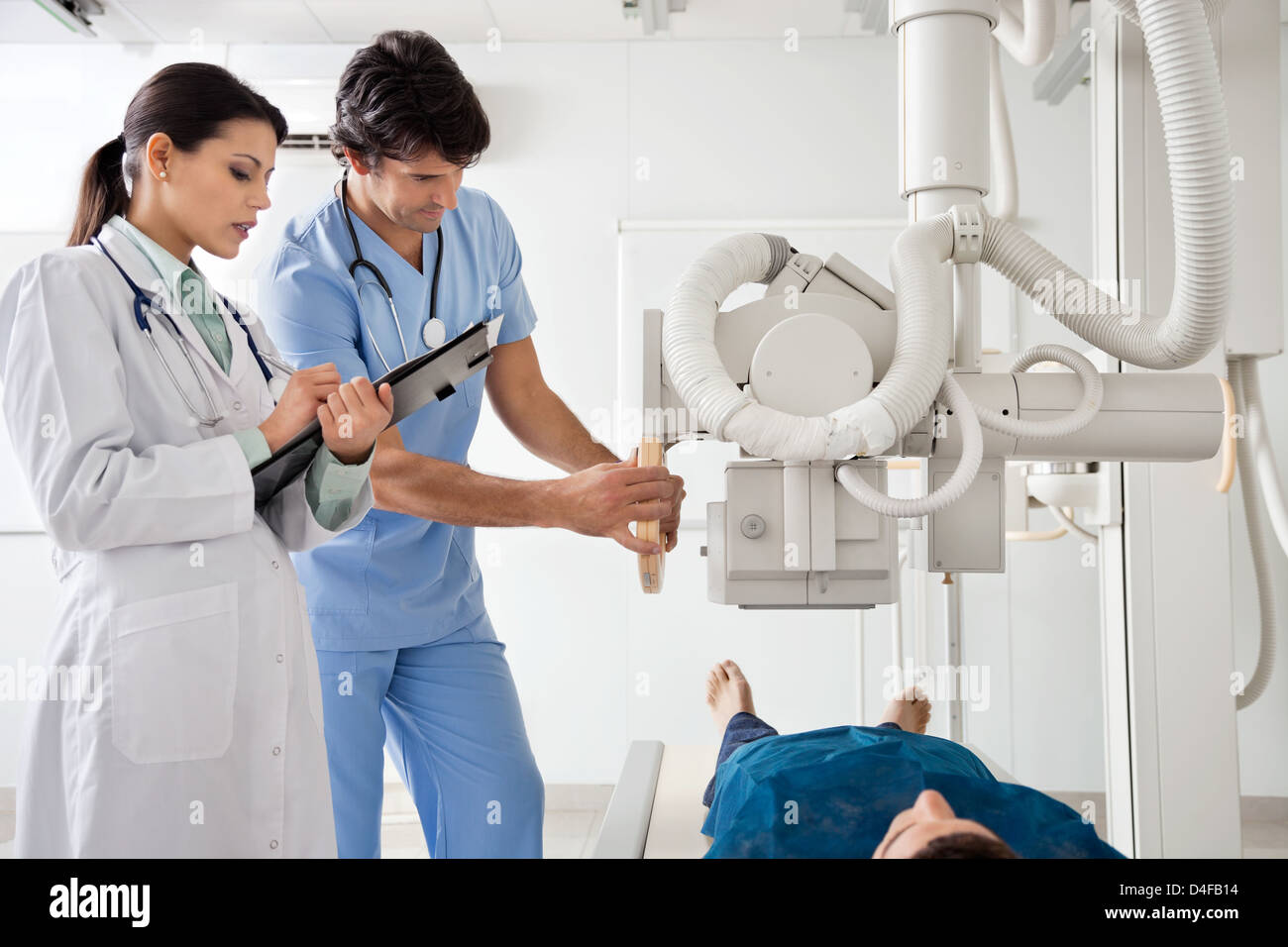 Radiologists Performing X-ray On Patient Stock Photo - Alamy