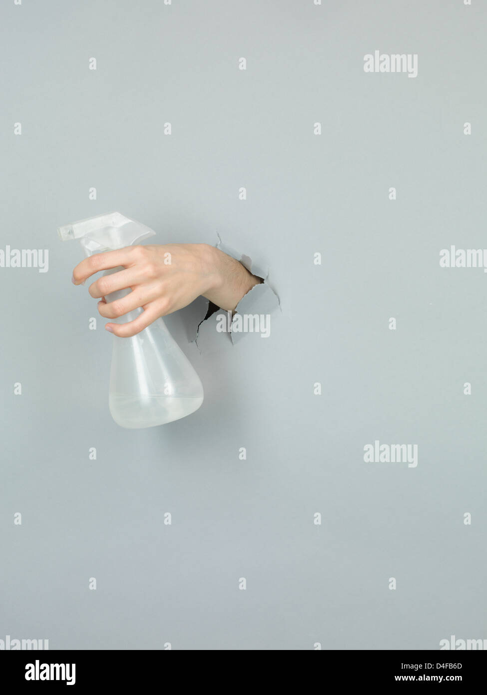 close-up of female hand holding a liquid detergent container through a ...