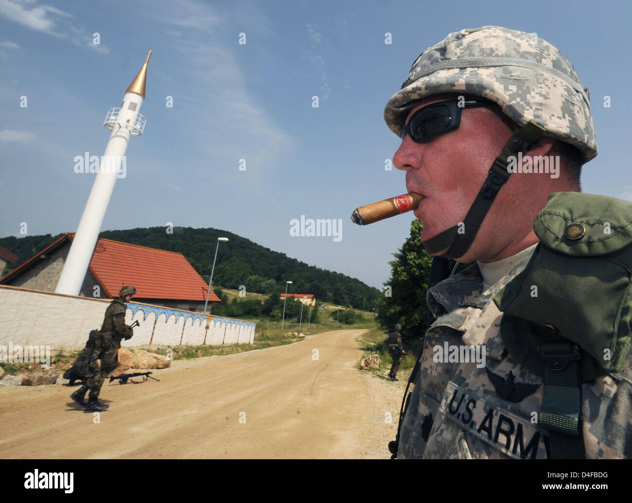 A US soldier smokes a cigar while standing outside a fake mosque at the ...