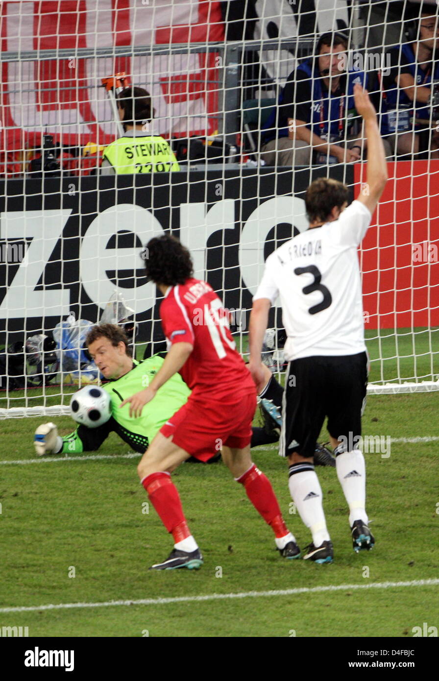 German goalkeeper Jens Lehmann (L) tries to save thoe shot of Ugur ...