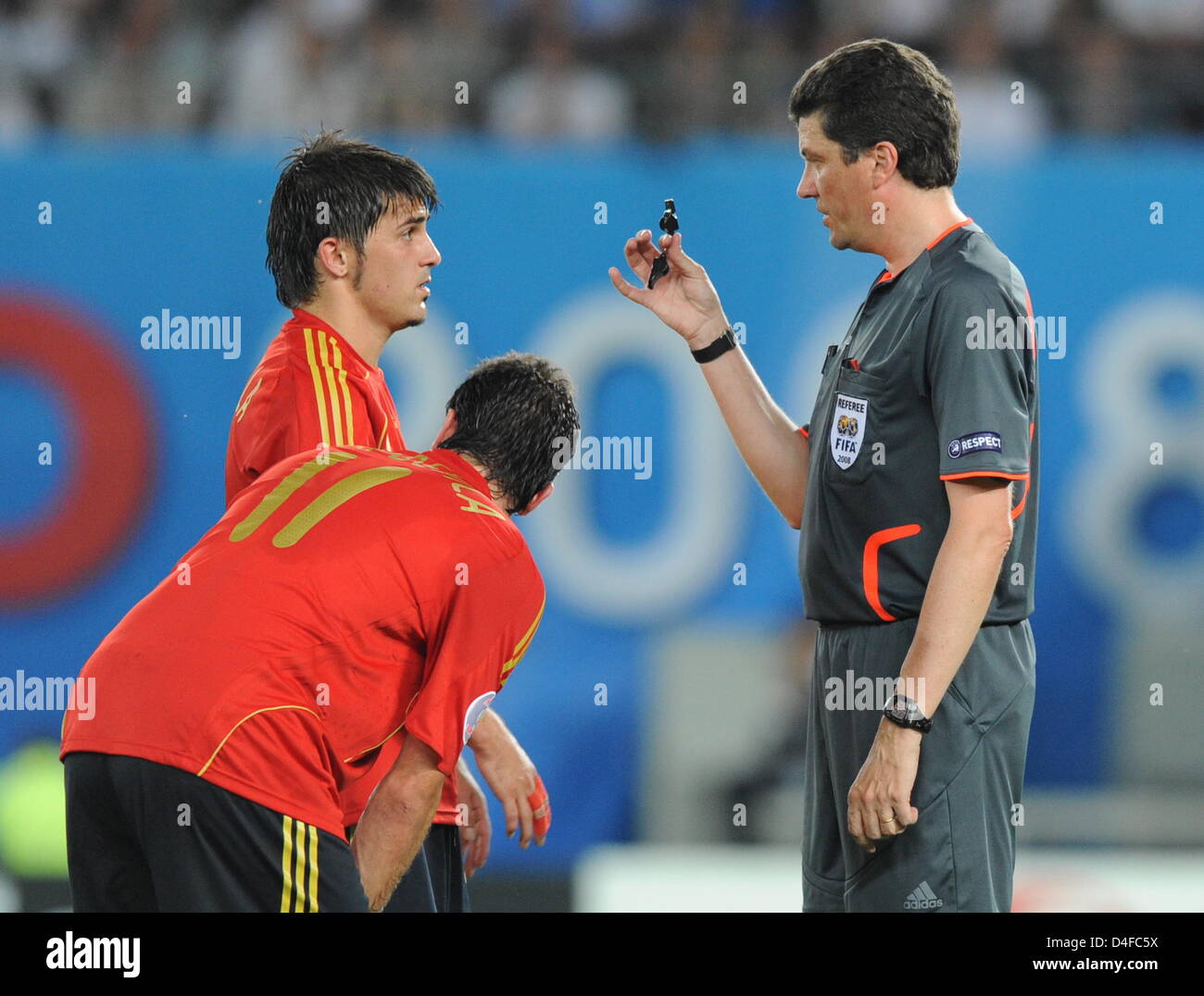 German referee Herbert Fandel (R) and David Villa of Spain (L) during ...