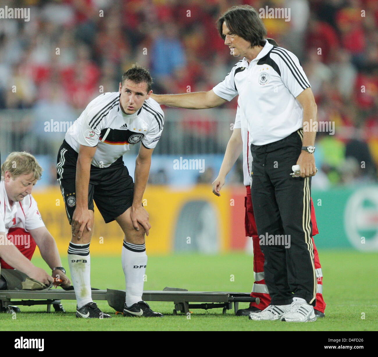 Miroslav Klose (L) of Germany and team doctor Hans-Wilhelm Mueller ...