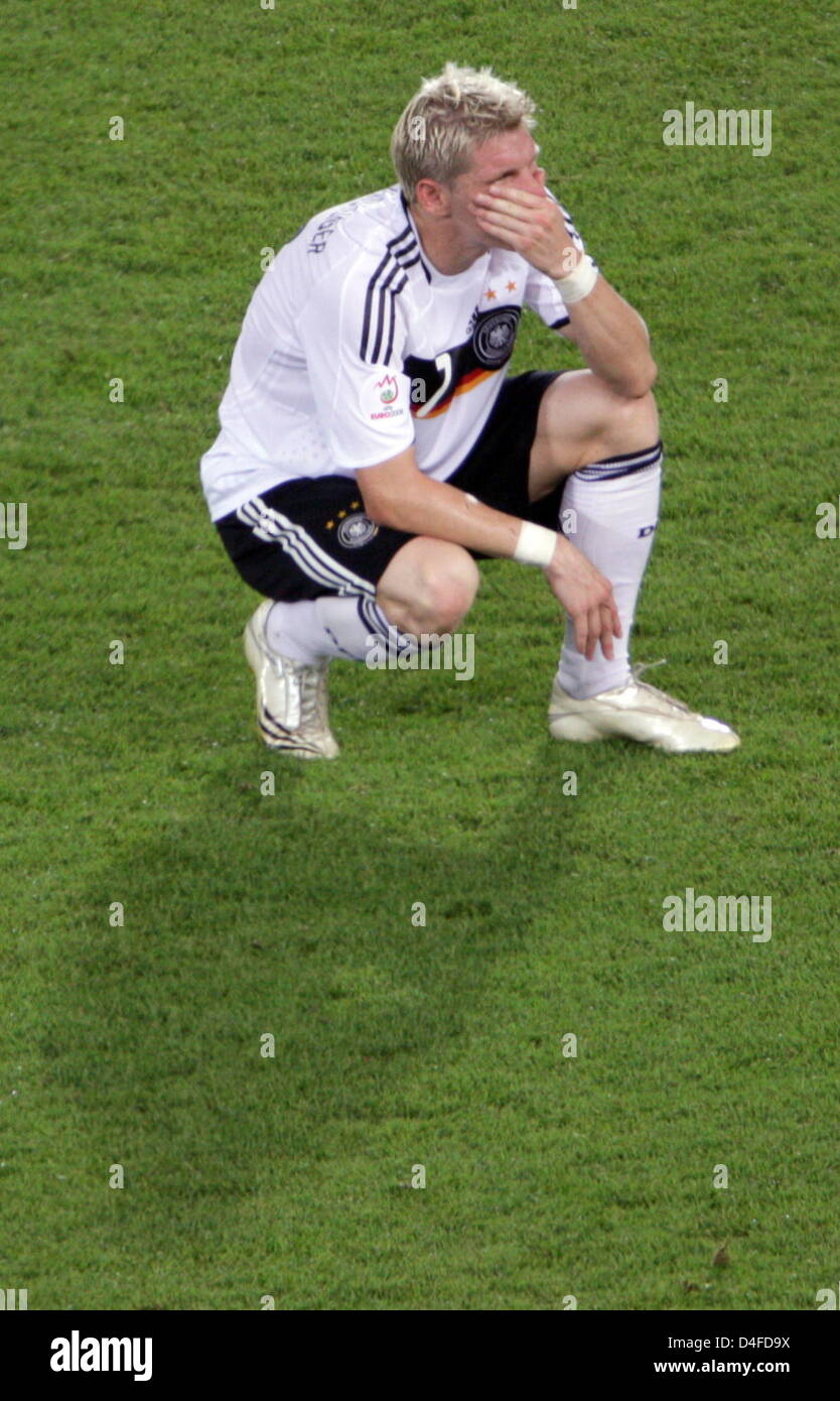 Dejected German player Bastian Schweinsteiger dejectedly crouches on ...