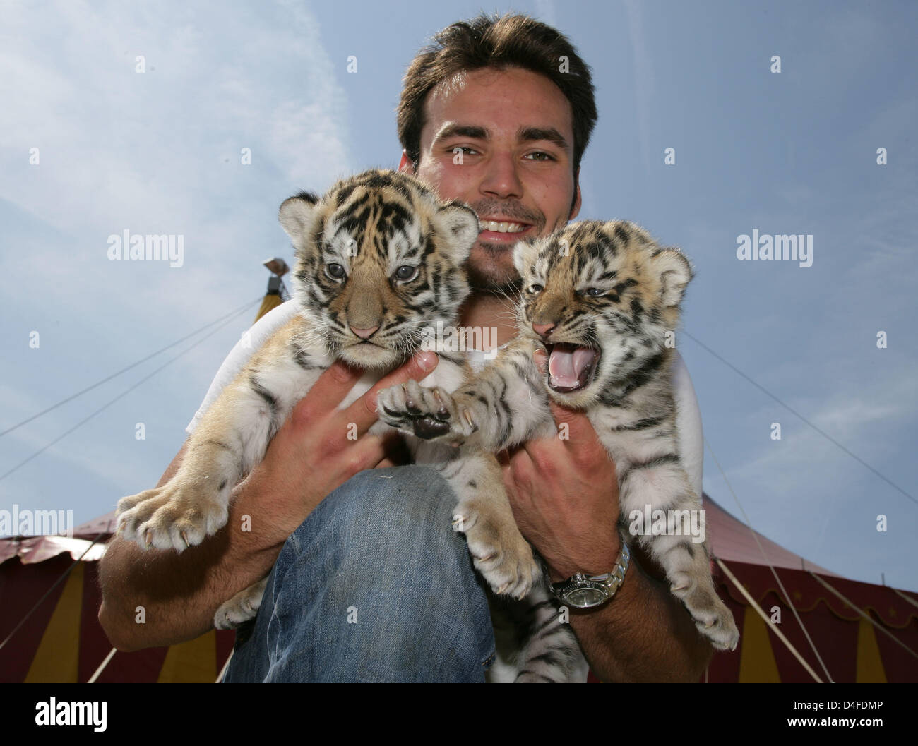 21 year-old animal tamer Dominique Fischer poses with two new born ...